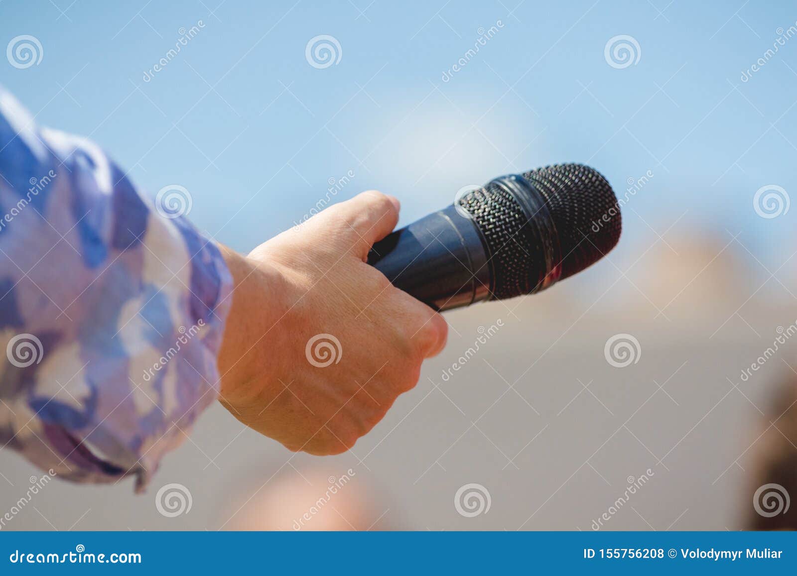 The Journalist Holds a Microphone in His Hand during an Interview ...
