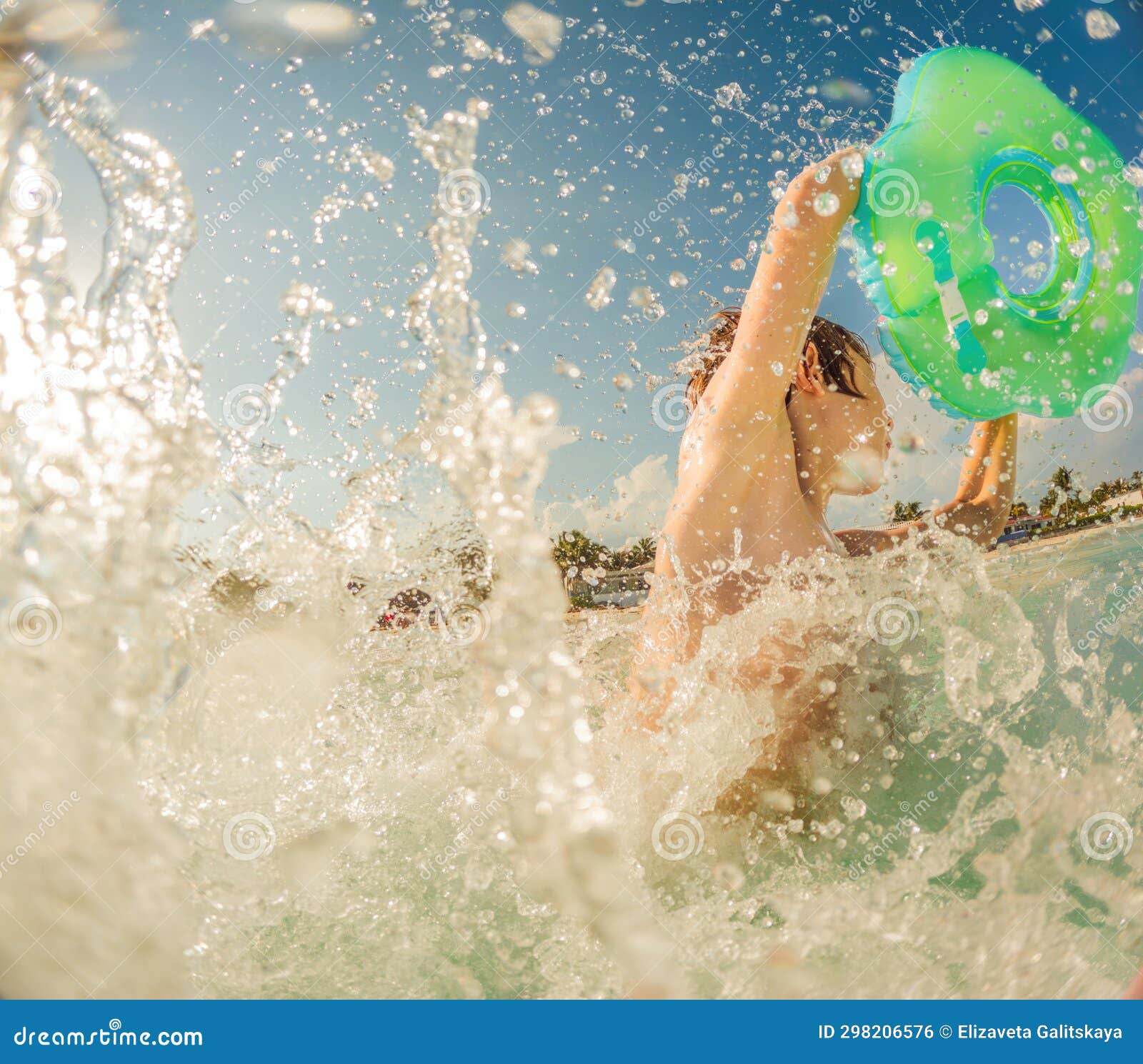 Joyful Boy Plays in the Sea, Creating Playful Splashes and Enjoying the Waves Stock Photo ...