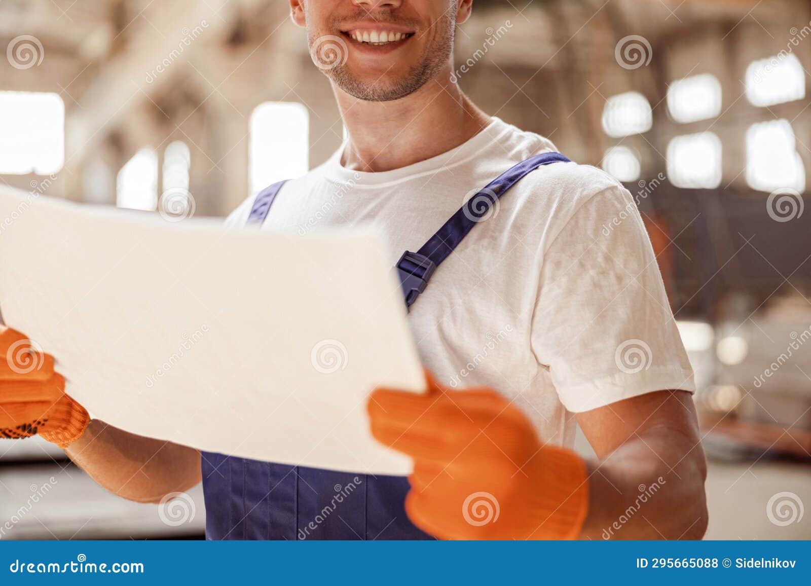 Joyful Builder with Architectural Plan Working at Construction Site ...