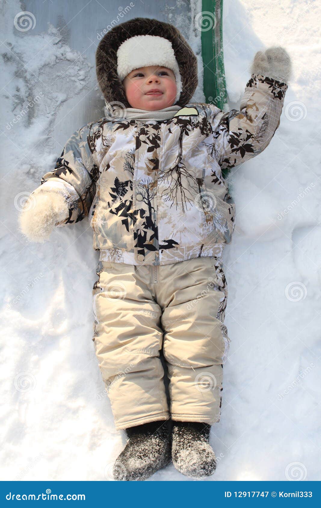 Child Slid Down A Snow Slide And Is Happy Lies On An Ice-boat Stock ...