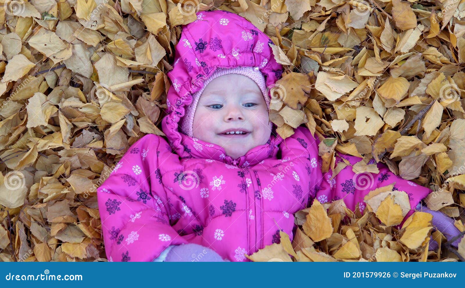 Joyful Child Lying Half in Fallen Leaves Stock Photo - Image of ...