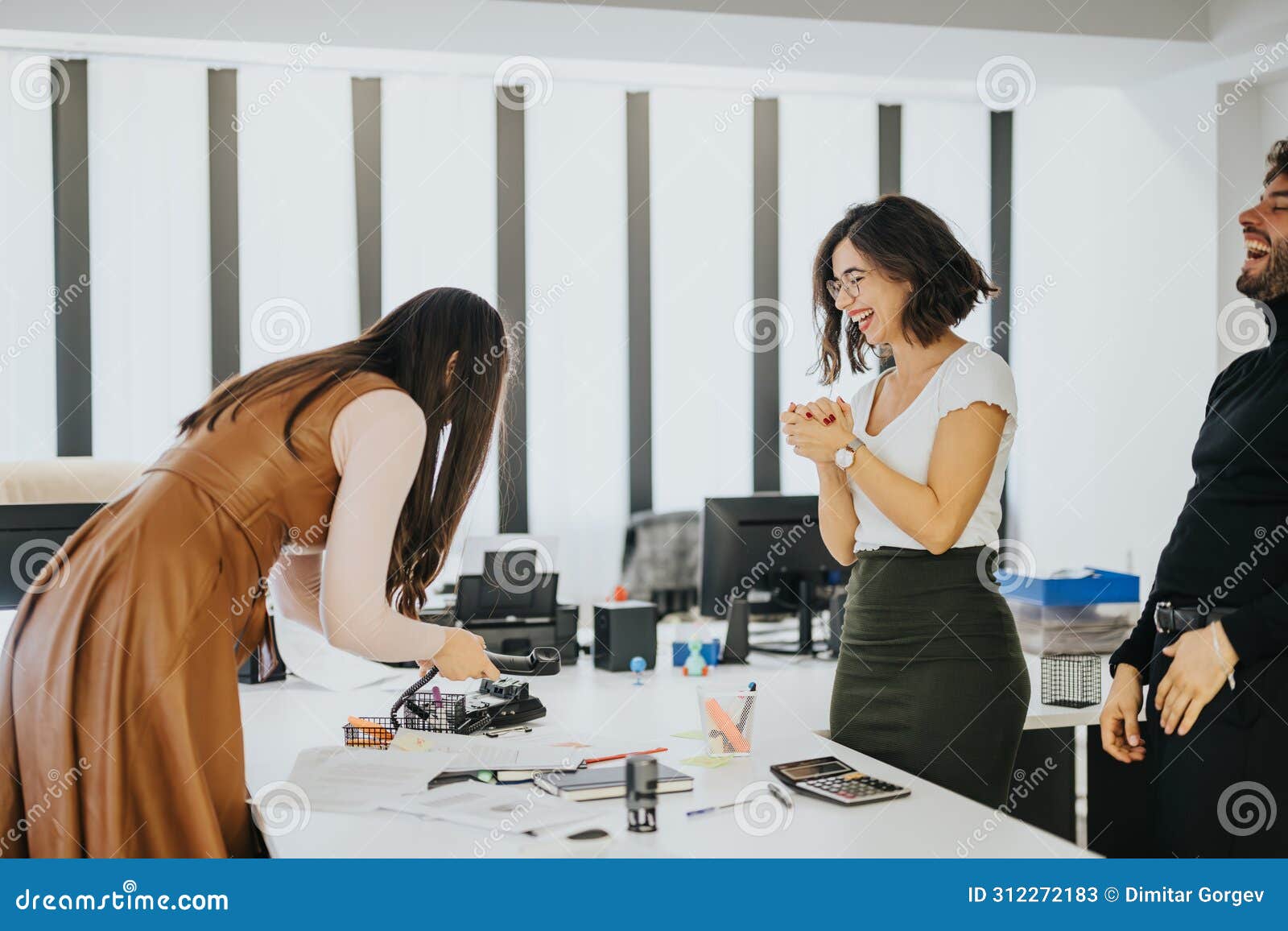 Joyful Colleagues Laughing and Interacting in a Modern Office ...