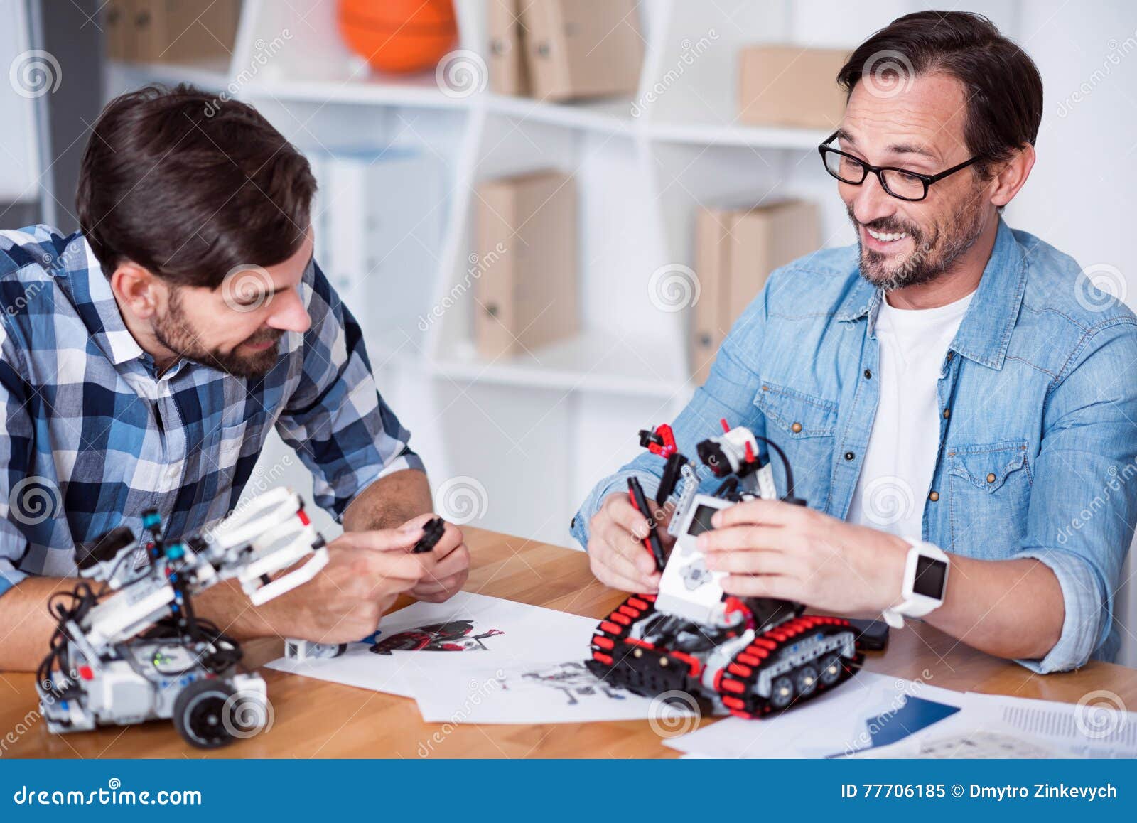 Joyful Colleagues Using Robot Stock Image - Image of inside, light ...