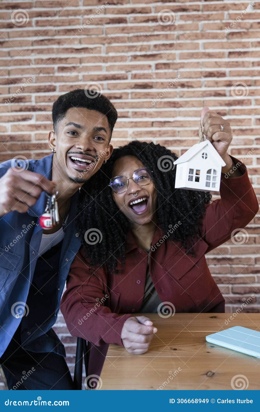 Joyful Couple Celebrating Buying New Home Showing Keys And Looking At