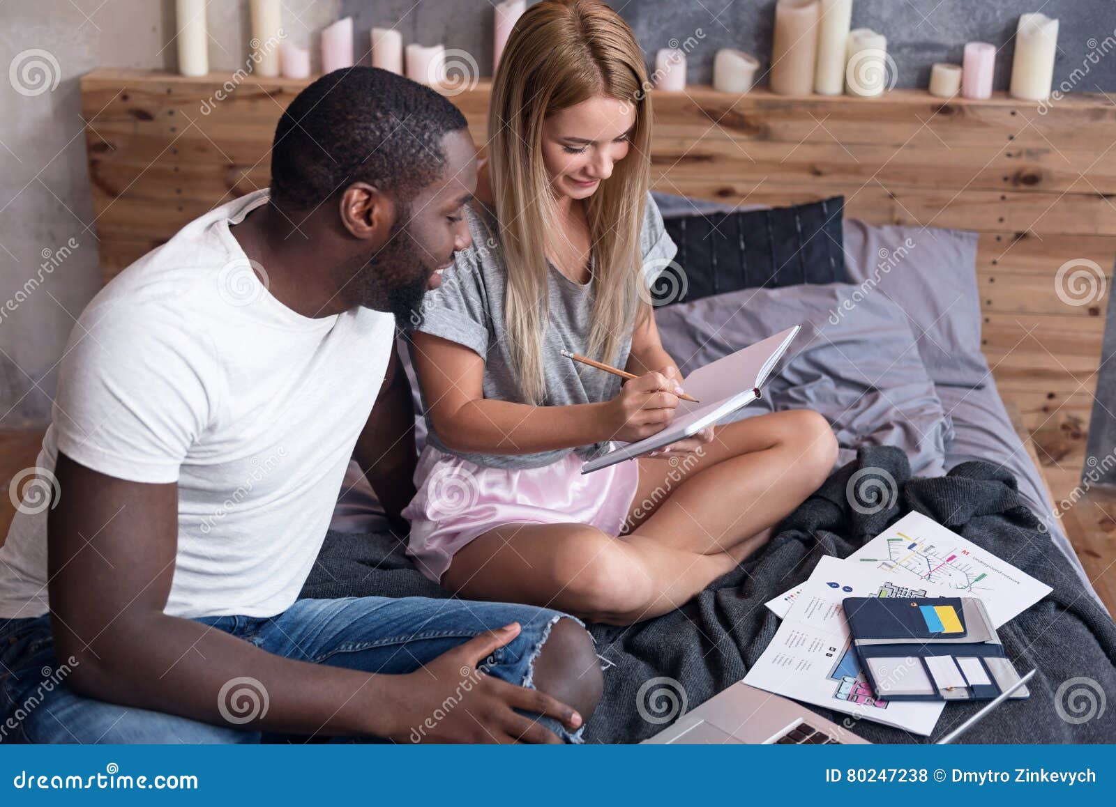 Joyful Couple Making Notes in Bedroom Together Stock Photo - Image of ...