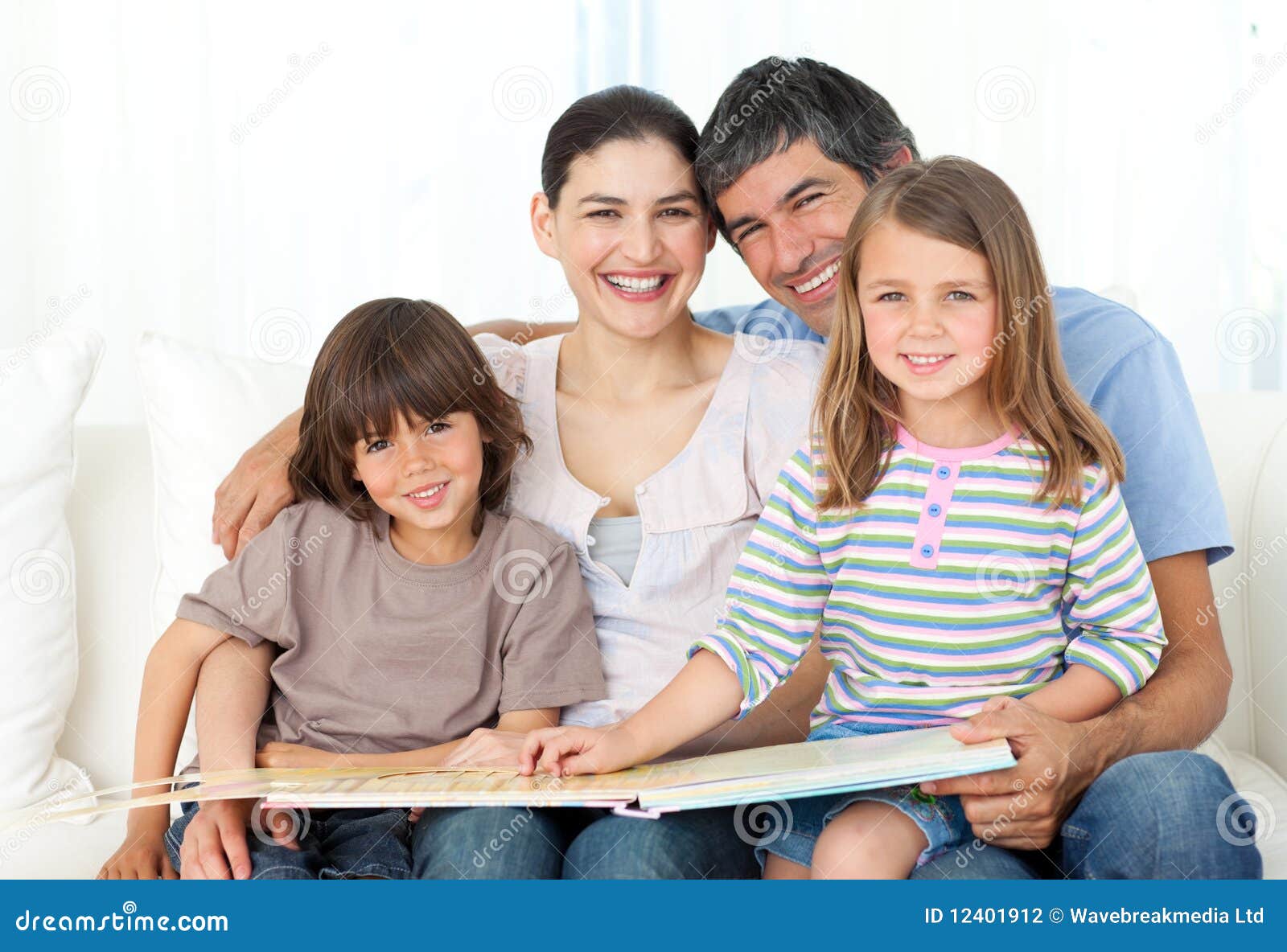 Joyful Family Reading Together on the Sofa Stock Photo - Image of ...