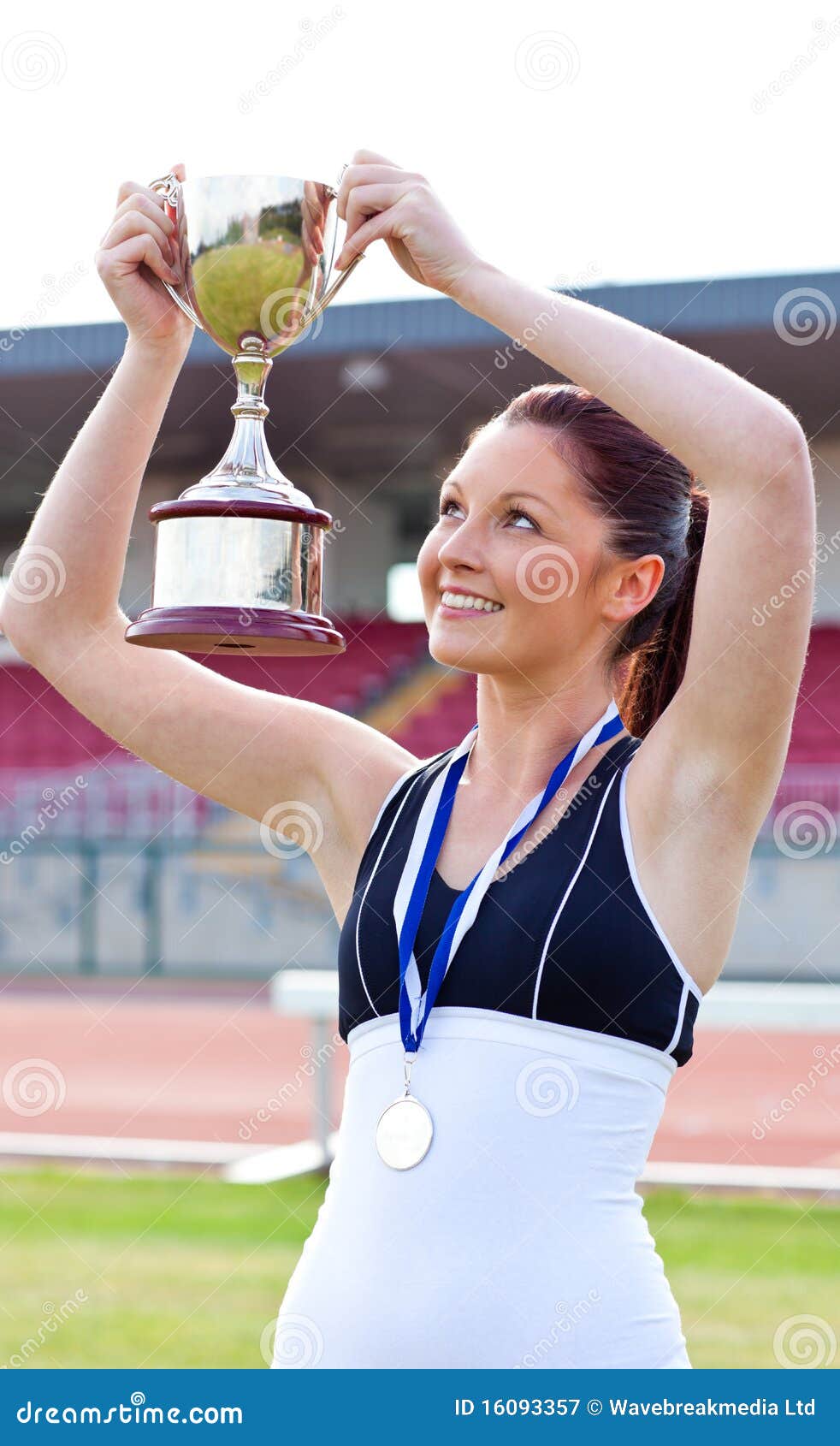 Joyful Female Athlete Holding a Trophy and a Medal Stock Image - Image ...