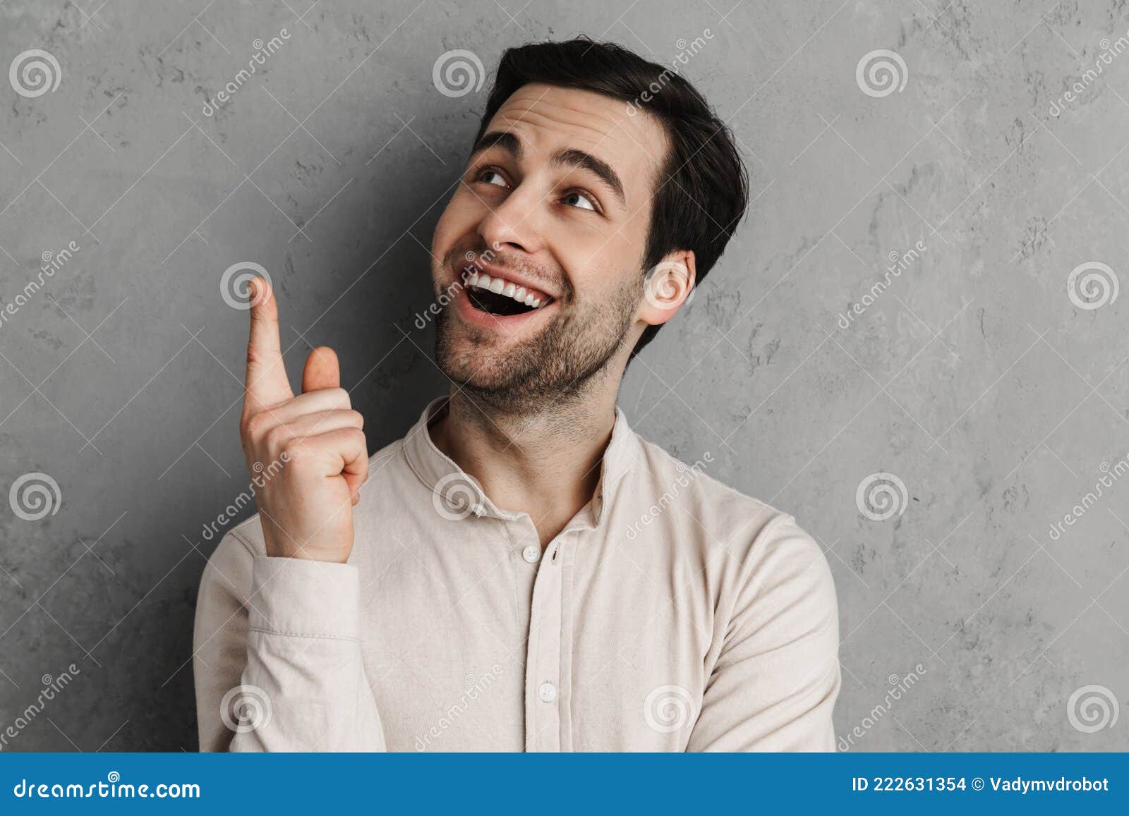 Joyful Handsome Guy Smiling and Pointing Finger Upward Stock Photo ...