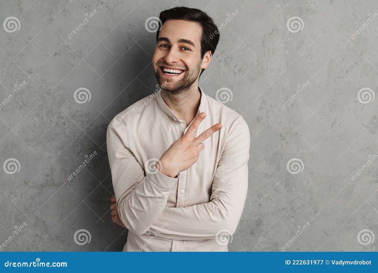 Joyful Handsome Guy Smiling and Showing Peace Sign Stock Image - Image ...