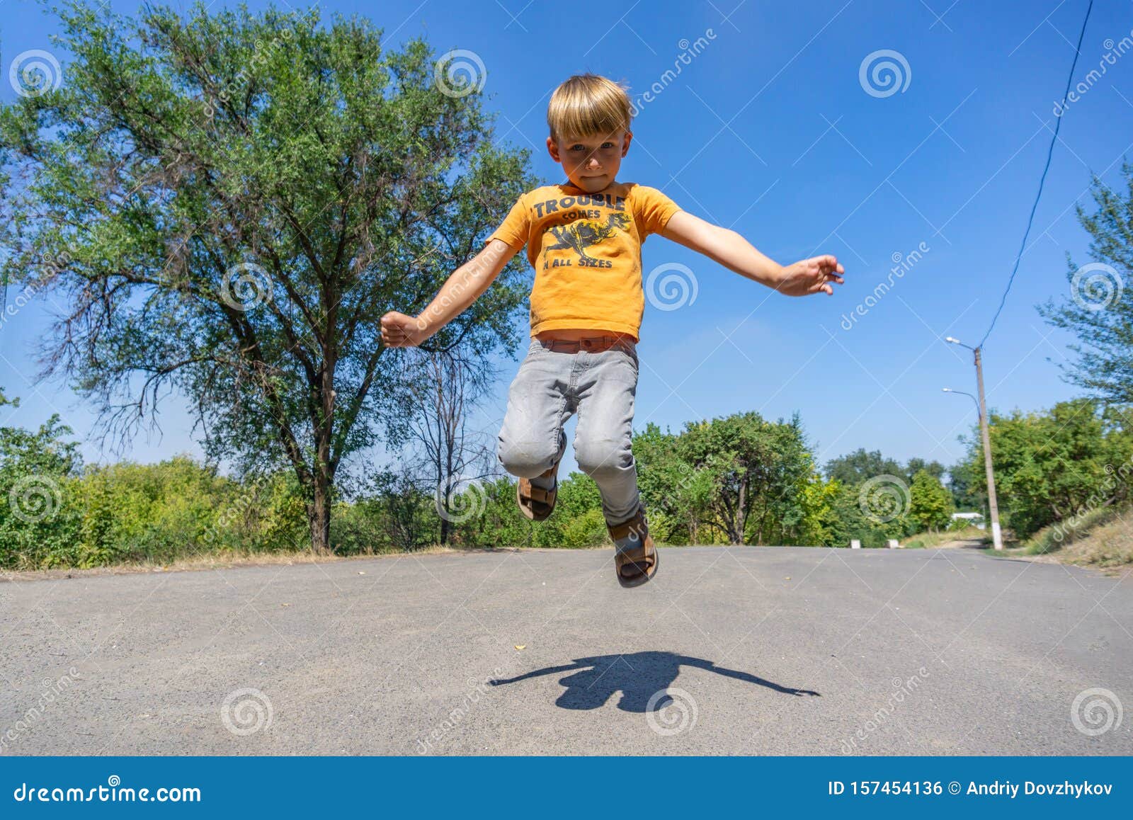 Joyful and Happy Boy is Jumping Up on the Road Stock Photo - Image of ...