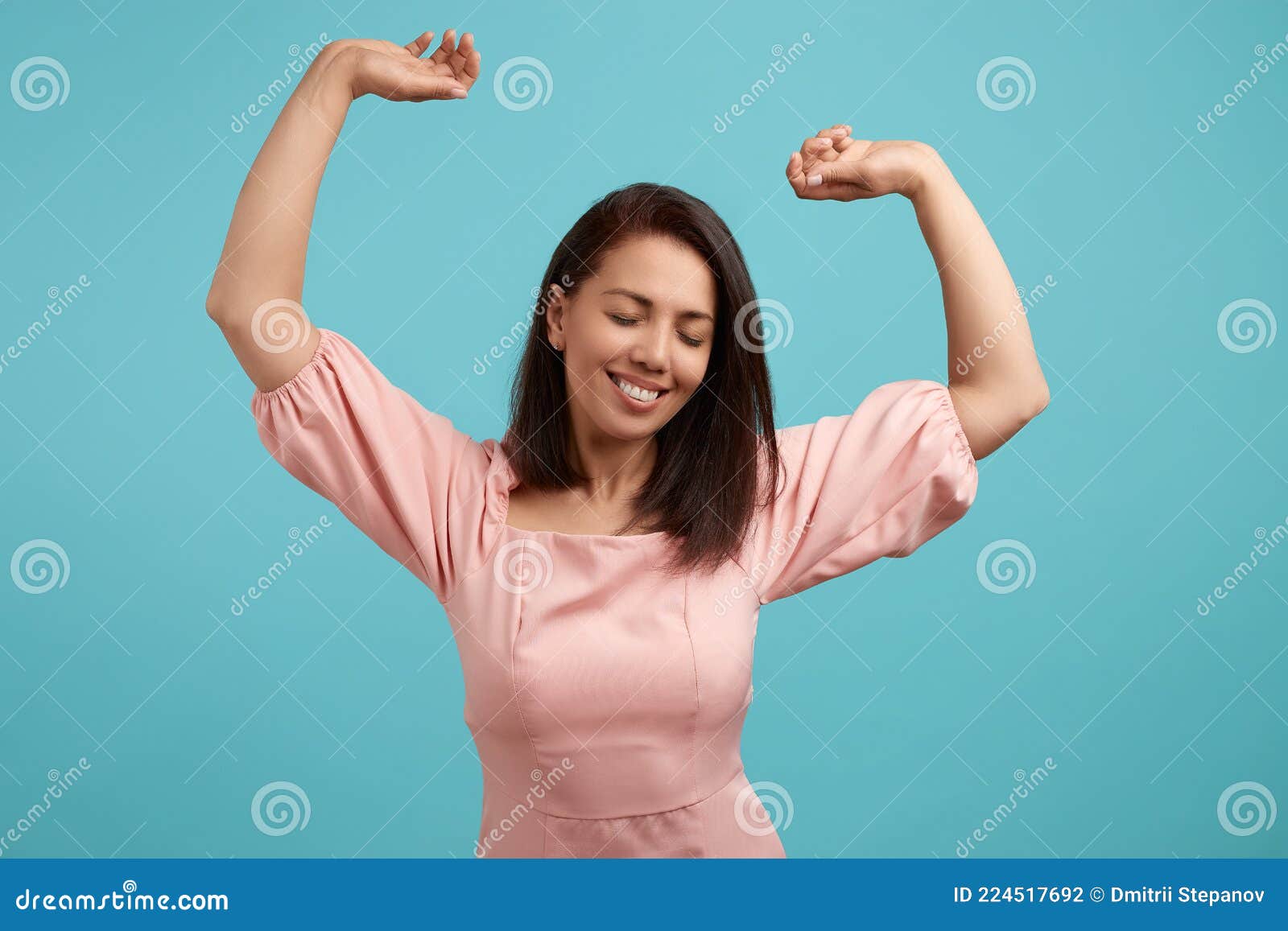 Joyful Happy Smiling Caucasian Woman With Dark Hair Wearing Pink Dress
