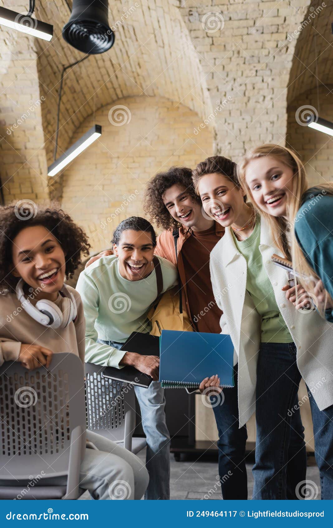Joyful Multicultural Students with Notebooks Looking Stock Image ...