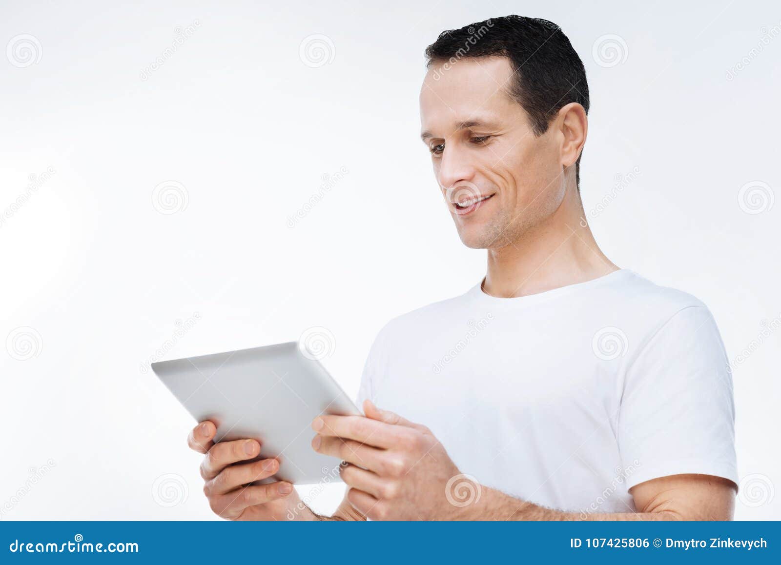 Joyful Positive Man Holding a Tablet Stock Photo - Image of joyful ... Joyful Positive Man Holding a Tablet Stock Photo - Image of joyful ...