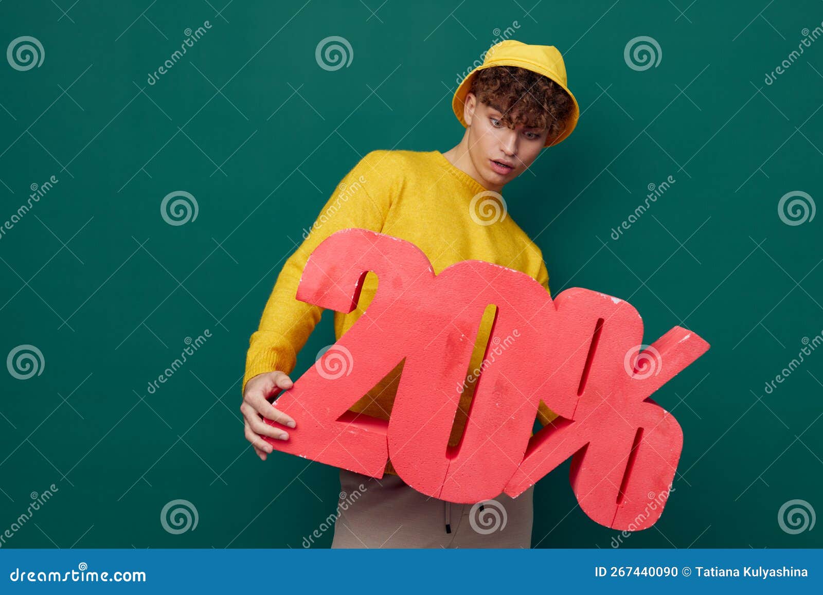 A Joyful Shocked Man Stands On A Green Background In Bright Clothes
