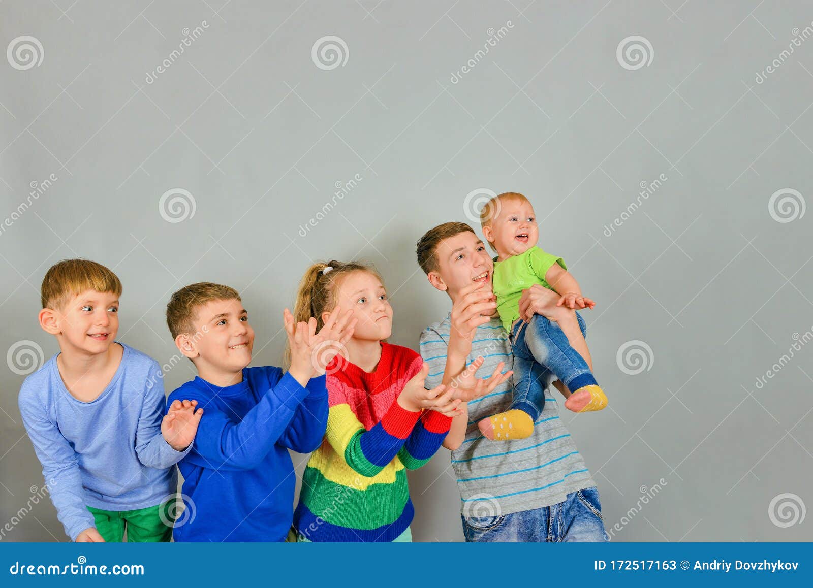 Joyful and Surprised Children Catch a Falling Object from Above. the ...
