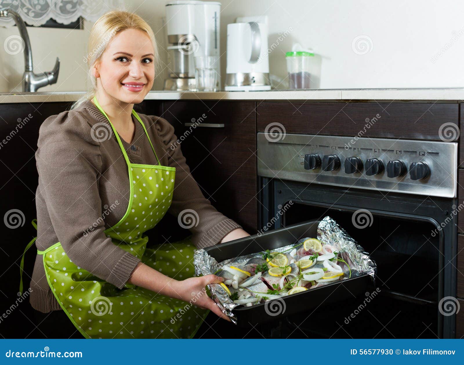 Joyful woman cooking fish stock photo. Image of girl - 56577930