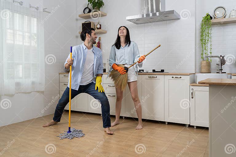Joyful Woman Singing Songs And Dancing With Closed Eyes While Cleaning