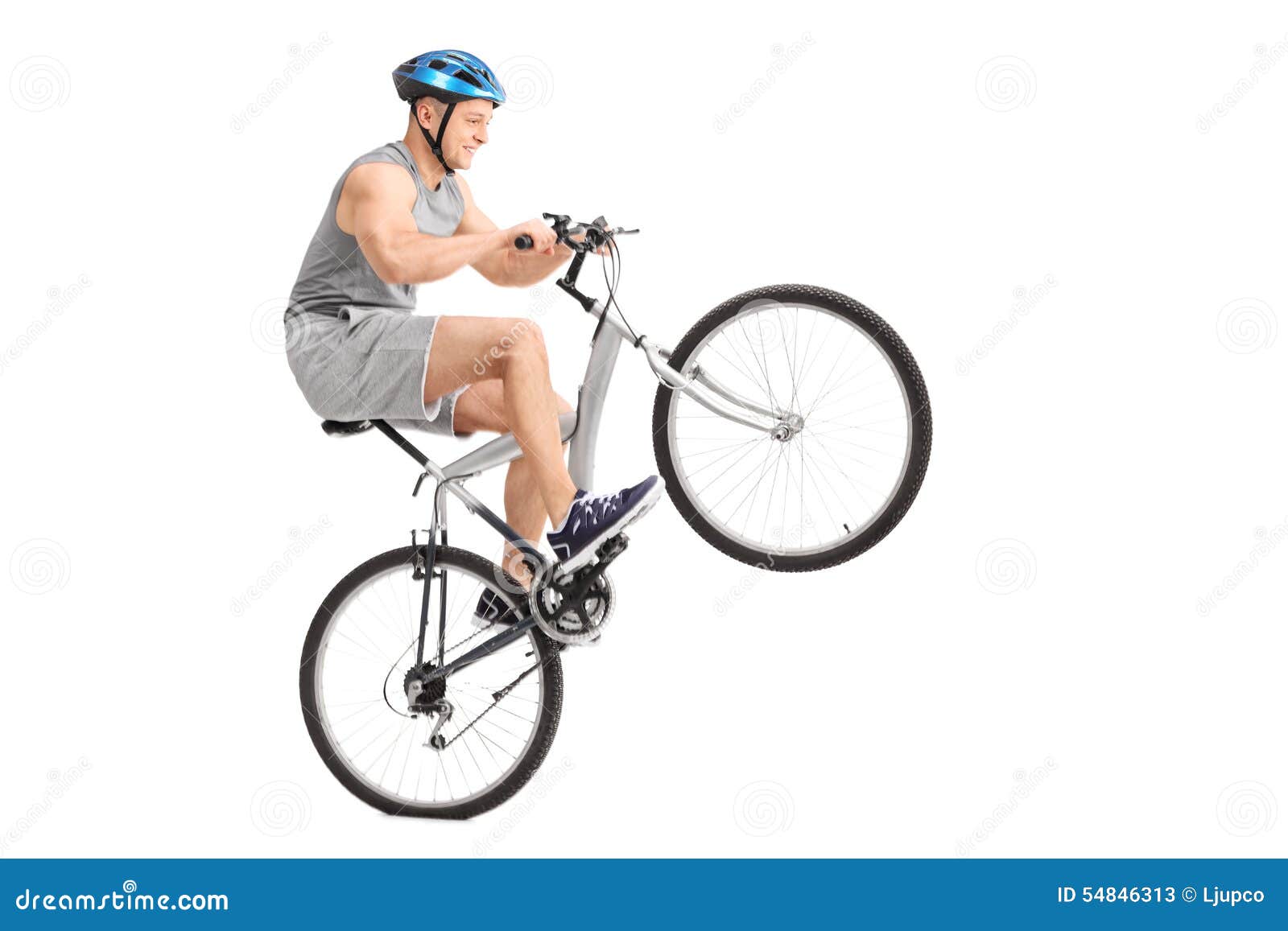 Joyful Young Biker Doing a Wheelie with His Bicycle Stock Image - Image ...