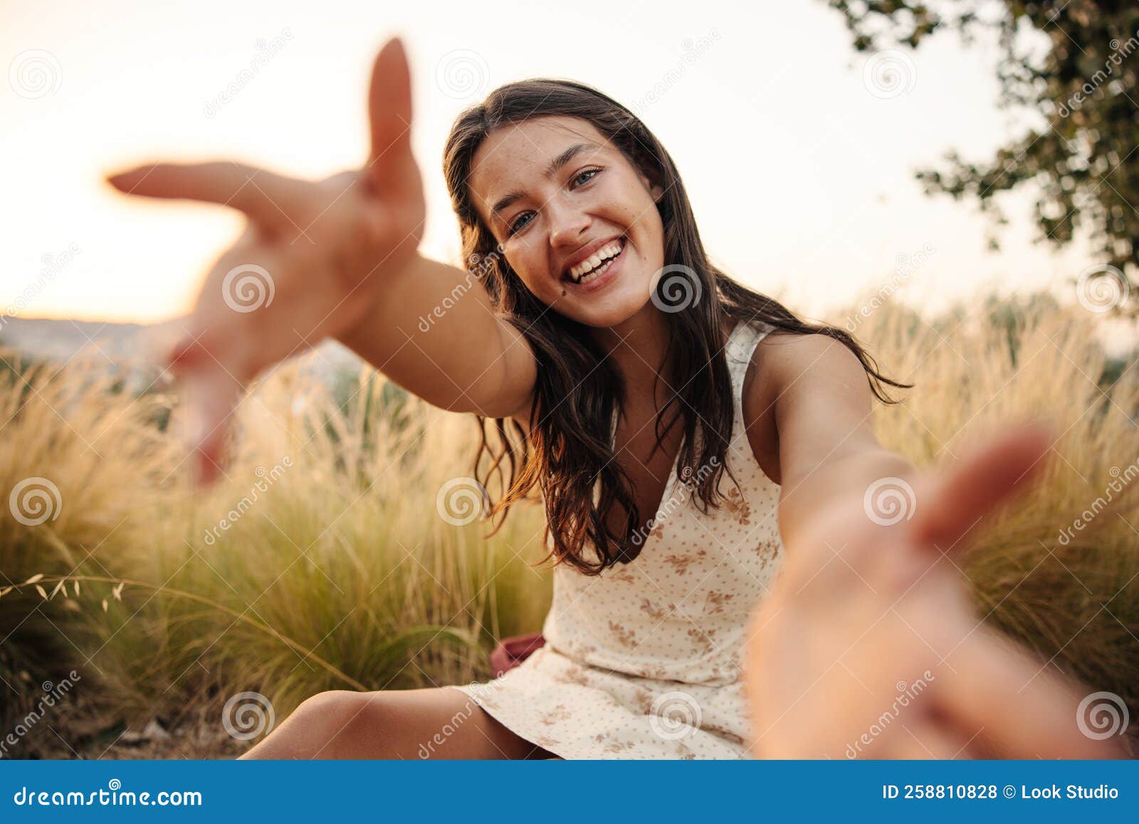 Joyful Young Caucasian Woman Smiles With Teeth Stretches Hands To