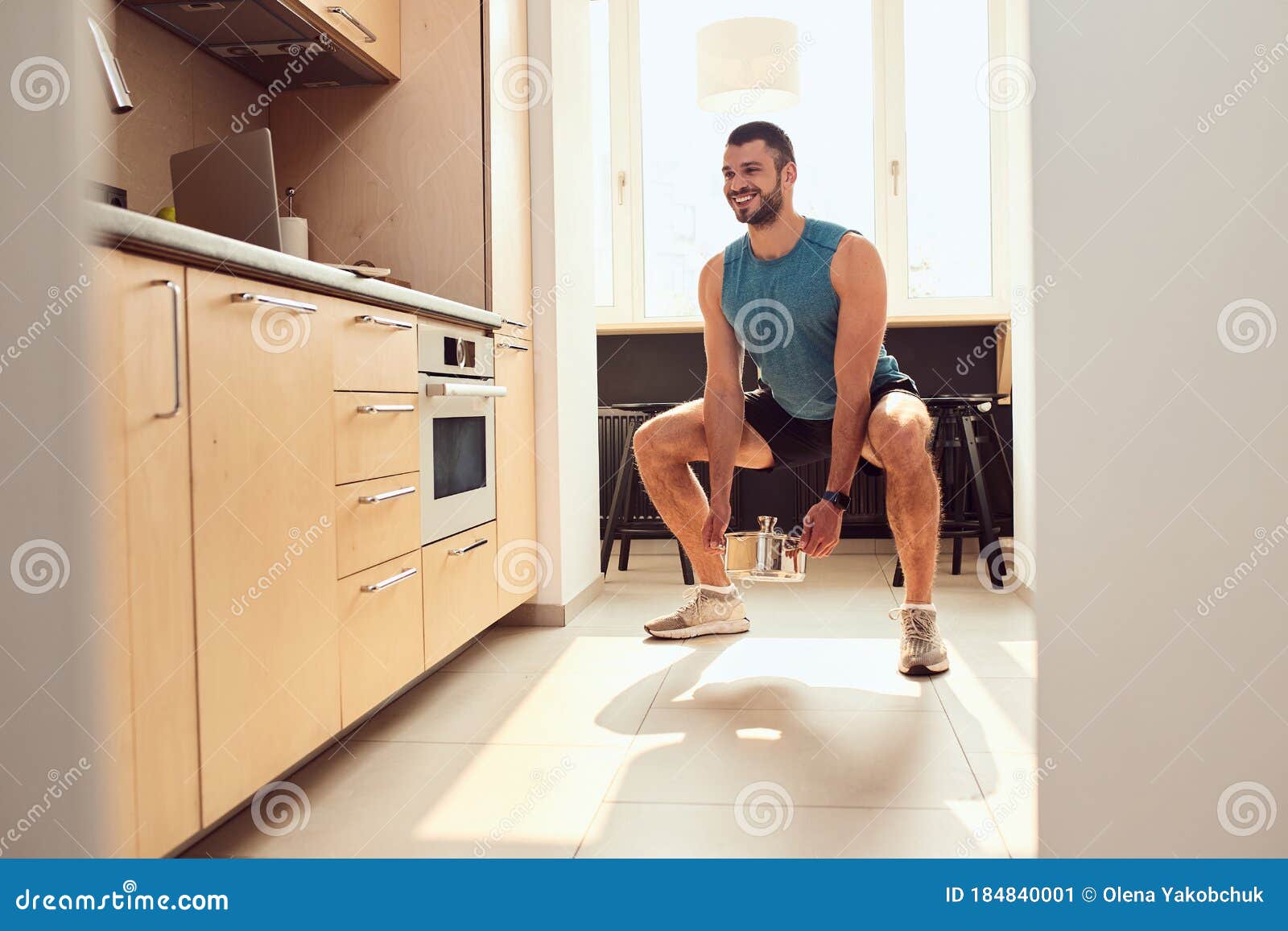 Joyful Young Man Doing Squats with Cooking Pot in Kitchen Stock Image ...