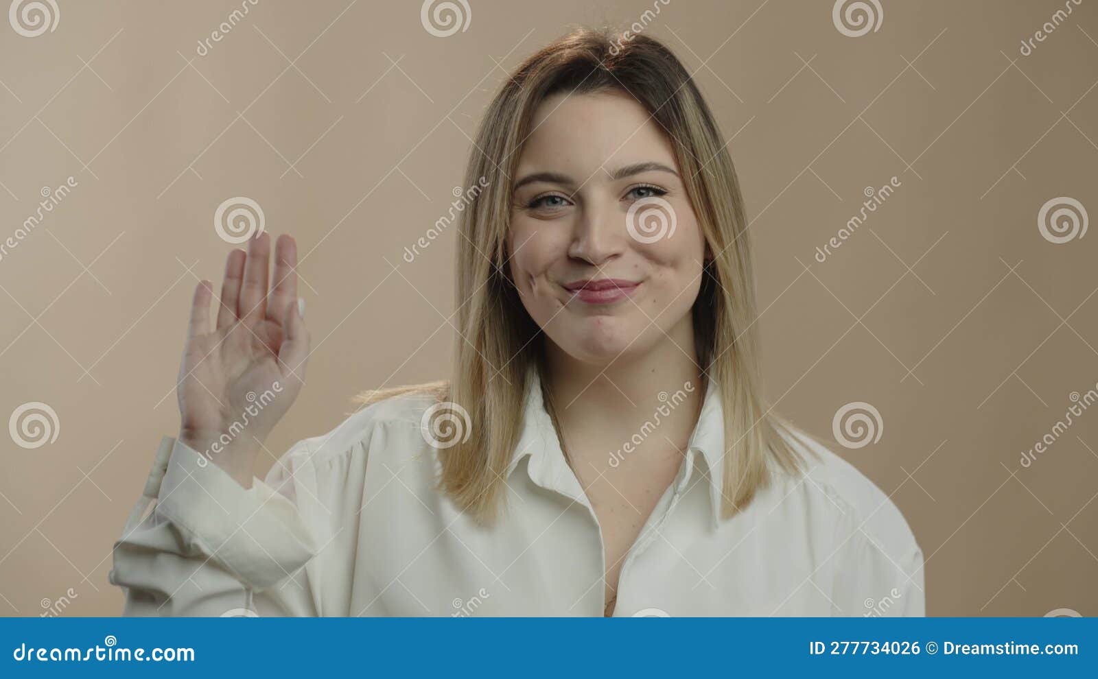 Joyful Young Woman Waving Hand To Camera Front View Of Girl In White