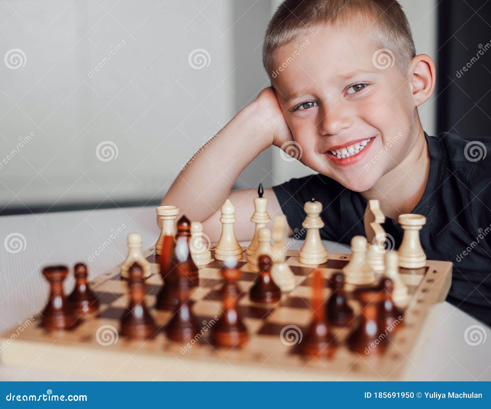 Joyfull boy plays chess stock photo. Image of challenge - 185691950