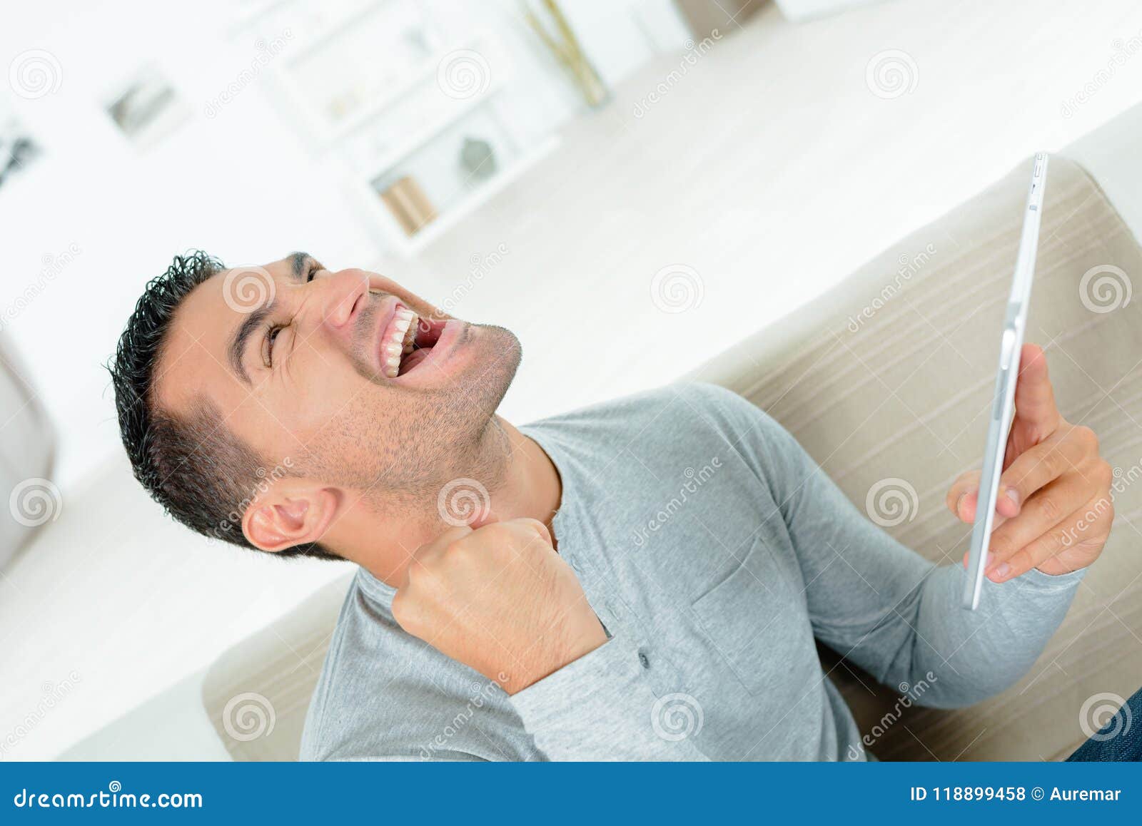 Jubilant Man Holding Tablet Computer Stock Photo - Image of punch ...