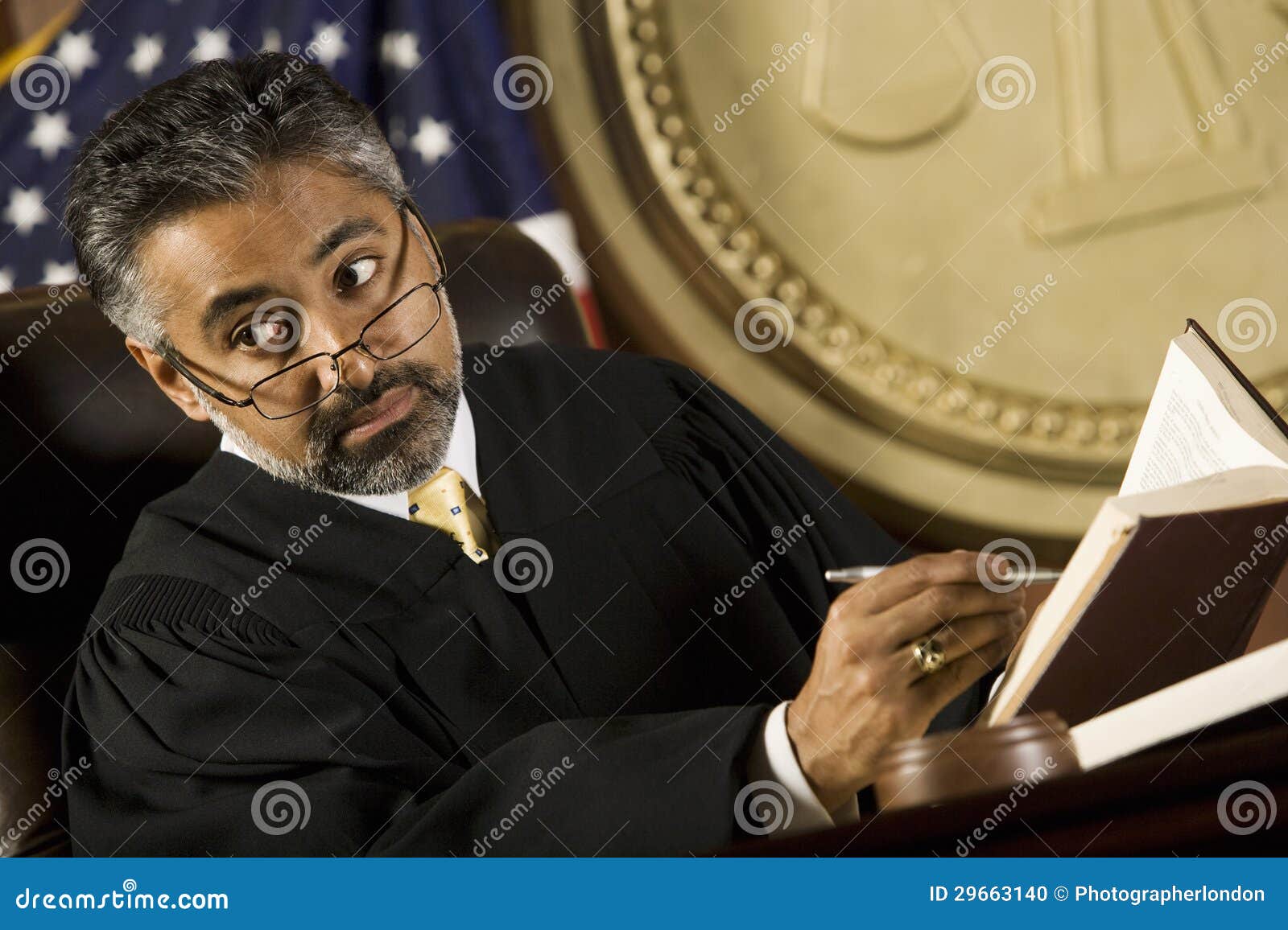 Judge Noting Important Points in Courtroom Stock Photo - Image of book ...
