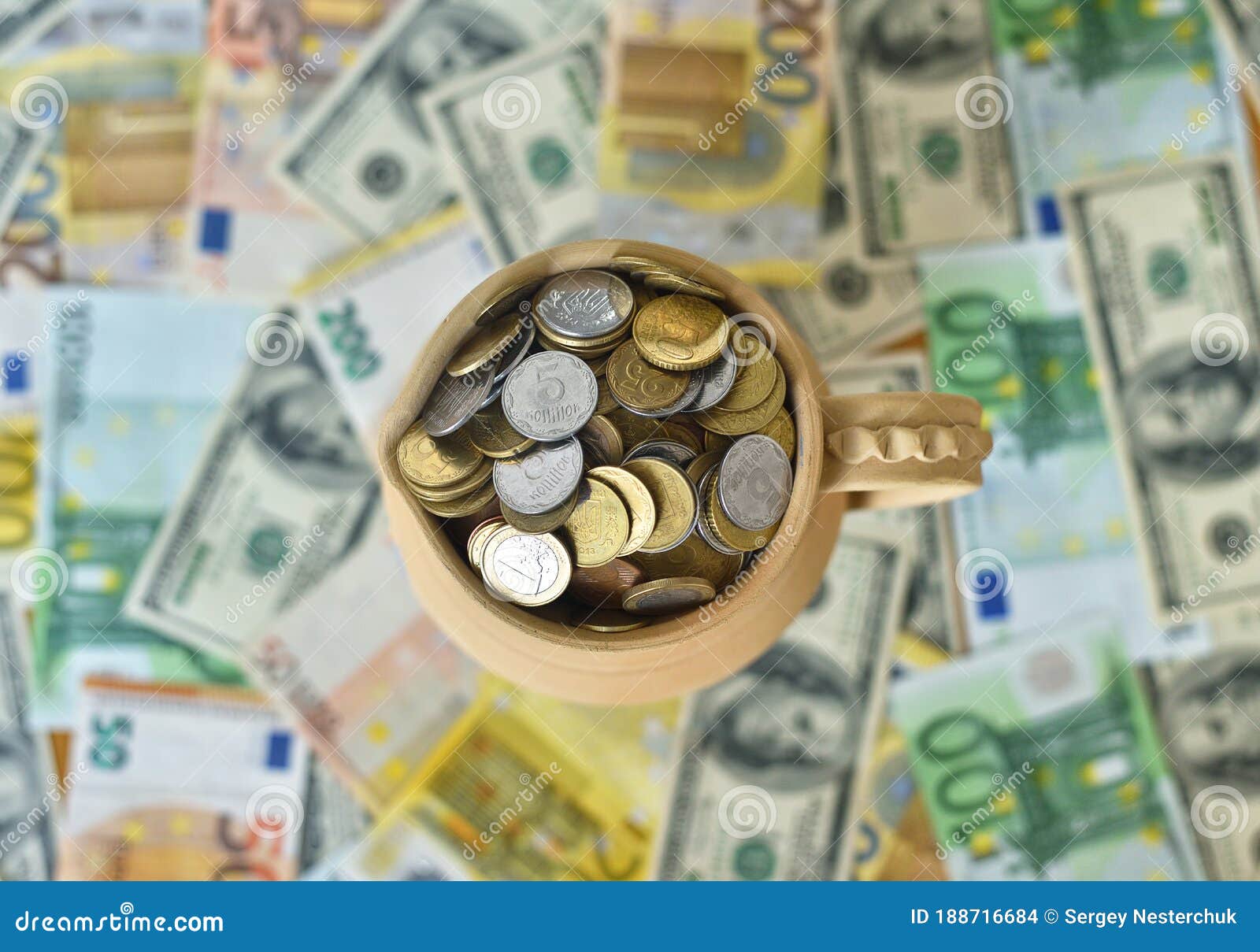 Jug with coins on a table stock photo. Image of banknote - 188716684
