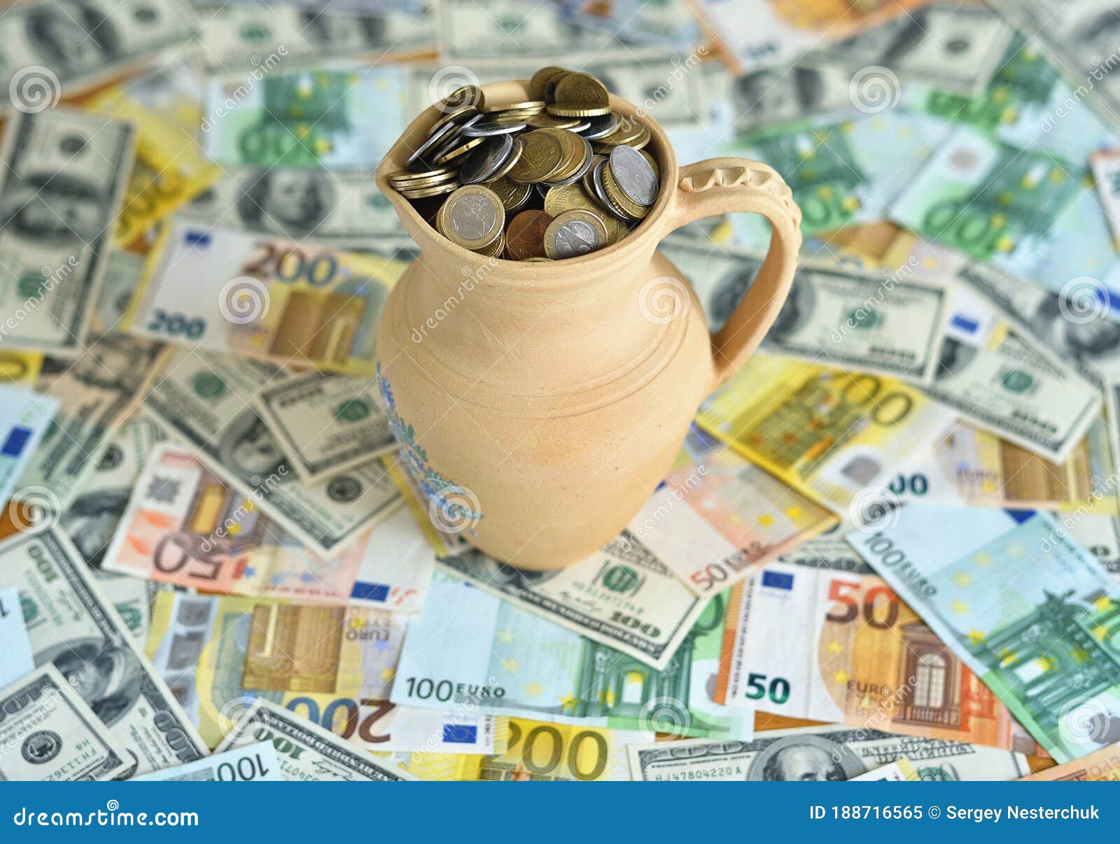 Jug with coins on a table stock image. Image of banknote - 188716565