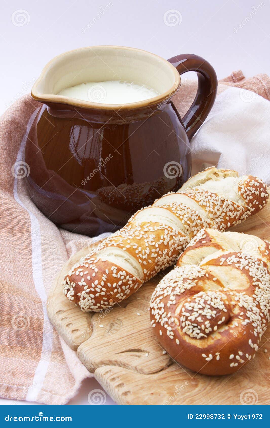 A Jug with Milk and Lye Pastry on the Wooden Board Stock Photo - Image ...