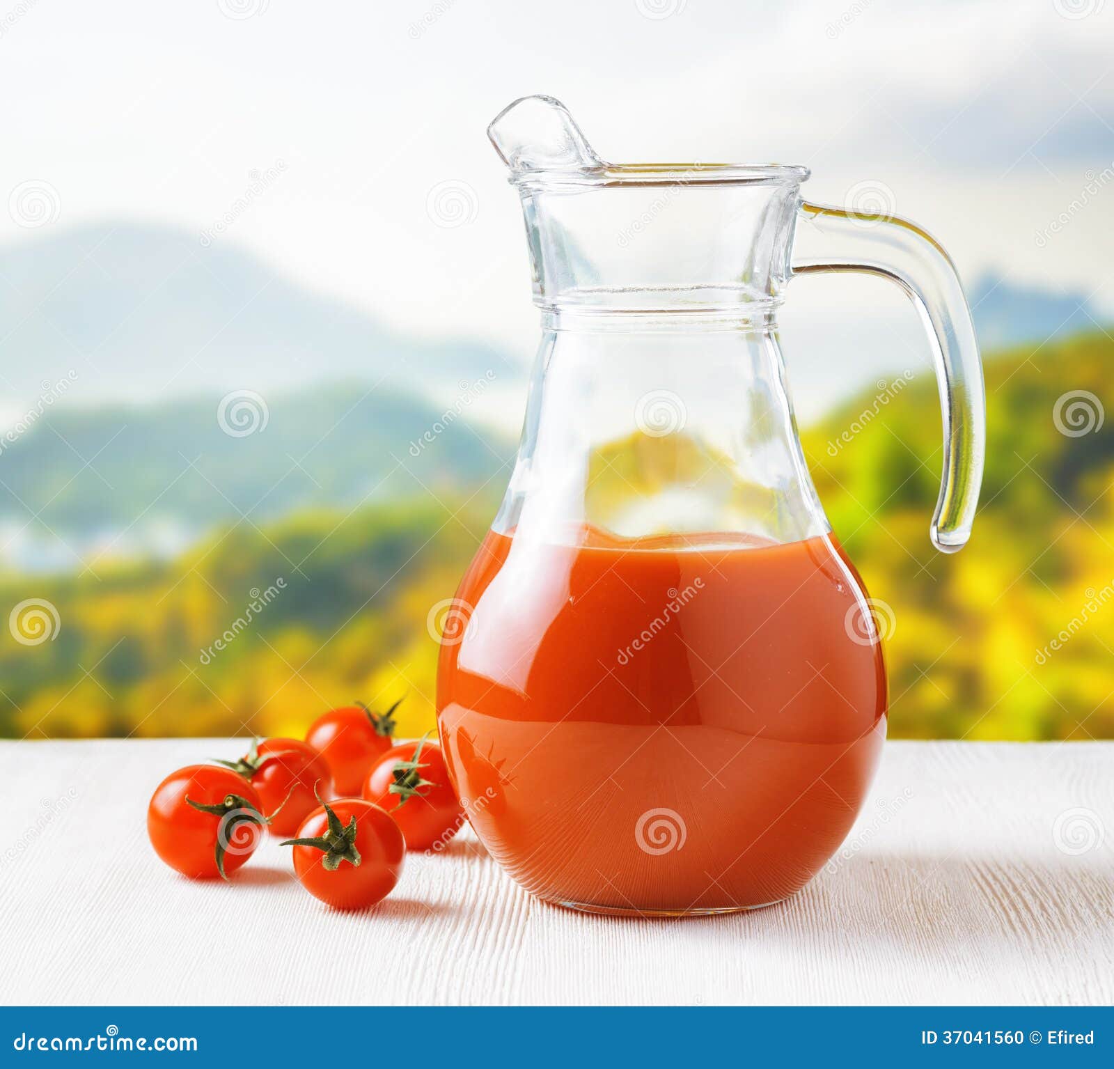 Jug of Tomato Juice on Nature Background. Half Full Pitcher Stock Photo ...