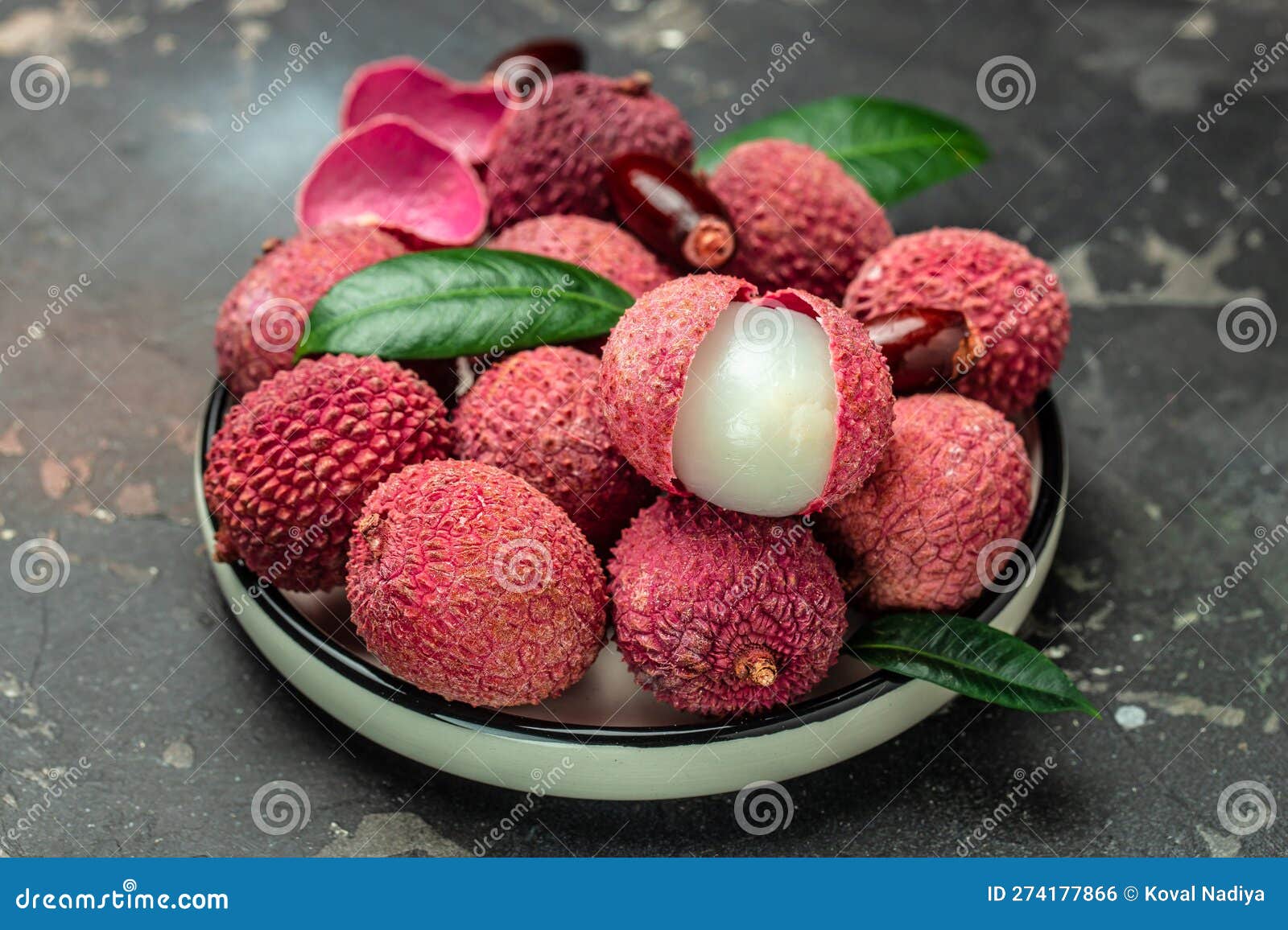 Juicy Lychee with Cut in Half and Leaves on Plate on a Dark Background ...