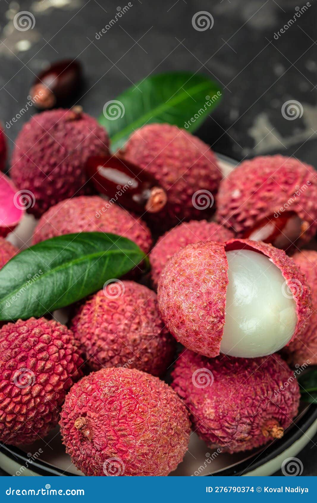 Juicy Lychee with Cut in Half and Leaves on Plate on a Dark Background ...