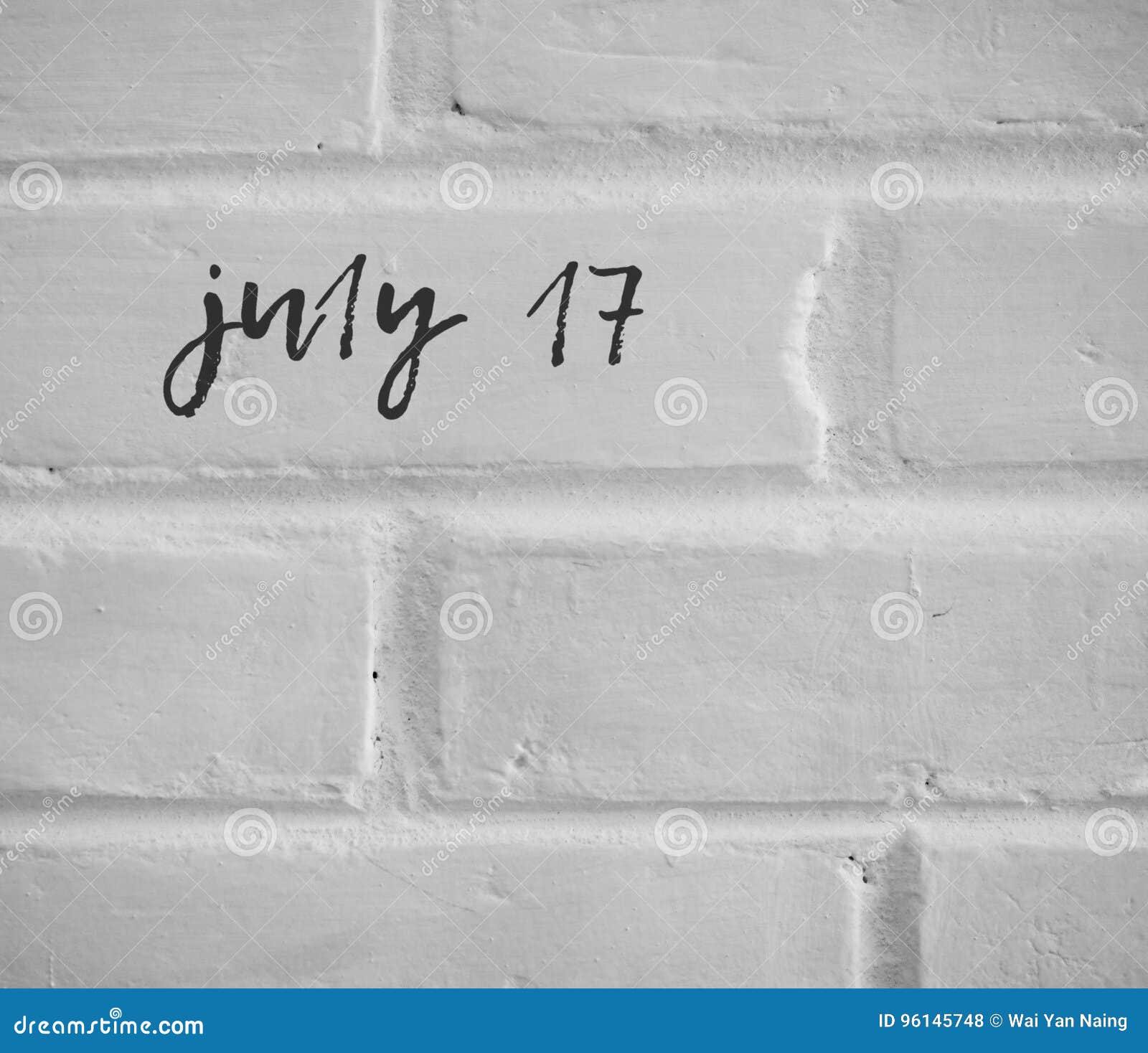 July 17 WRITTEN on WHITE PLAIN BRICK WALL Stock Photo - Image of season ...