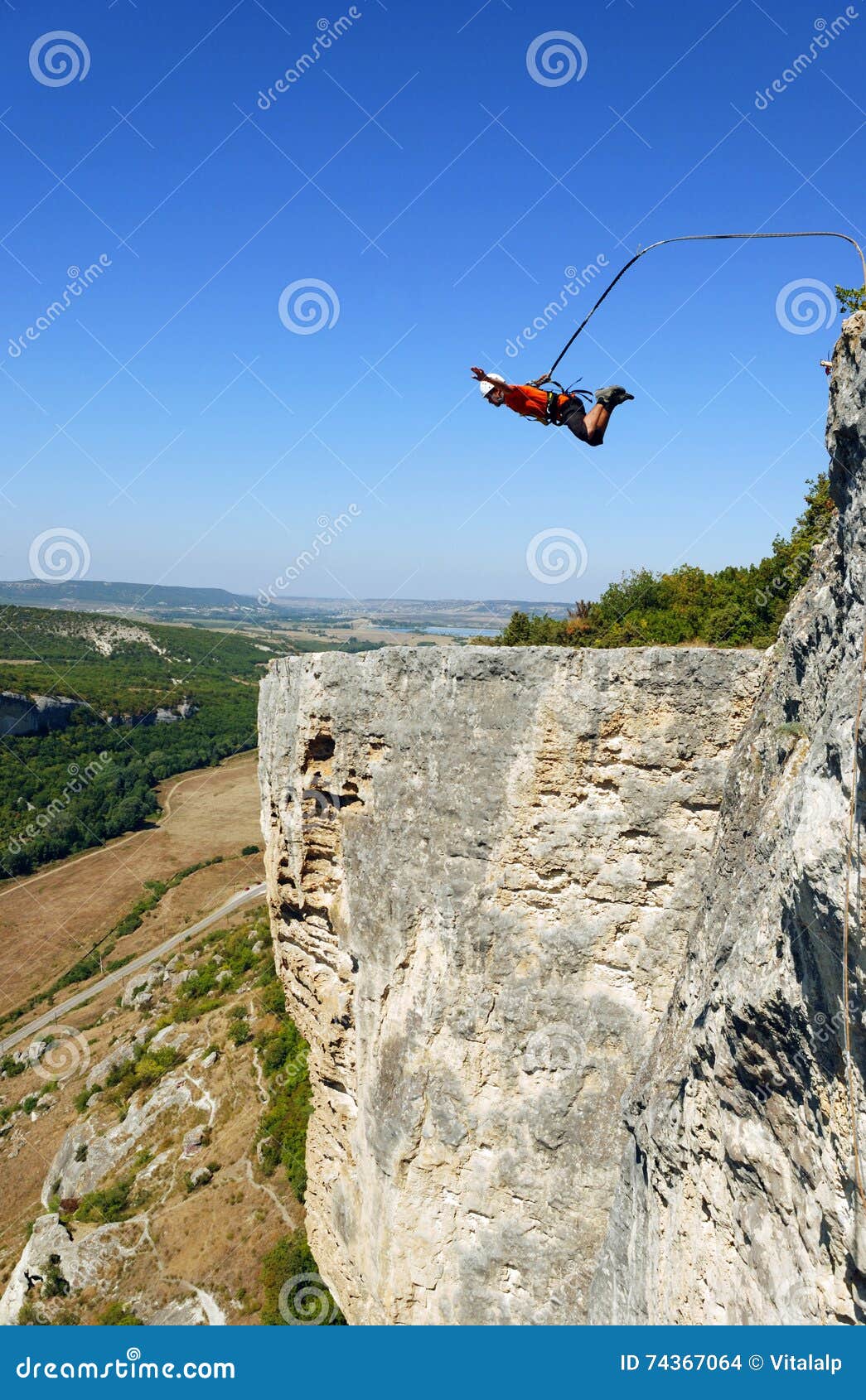 Jump off the cliff. stock photo. Image of rope, activity - 74367064