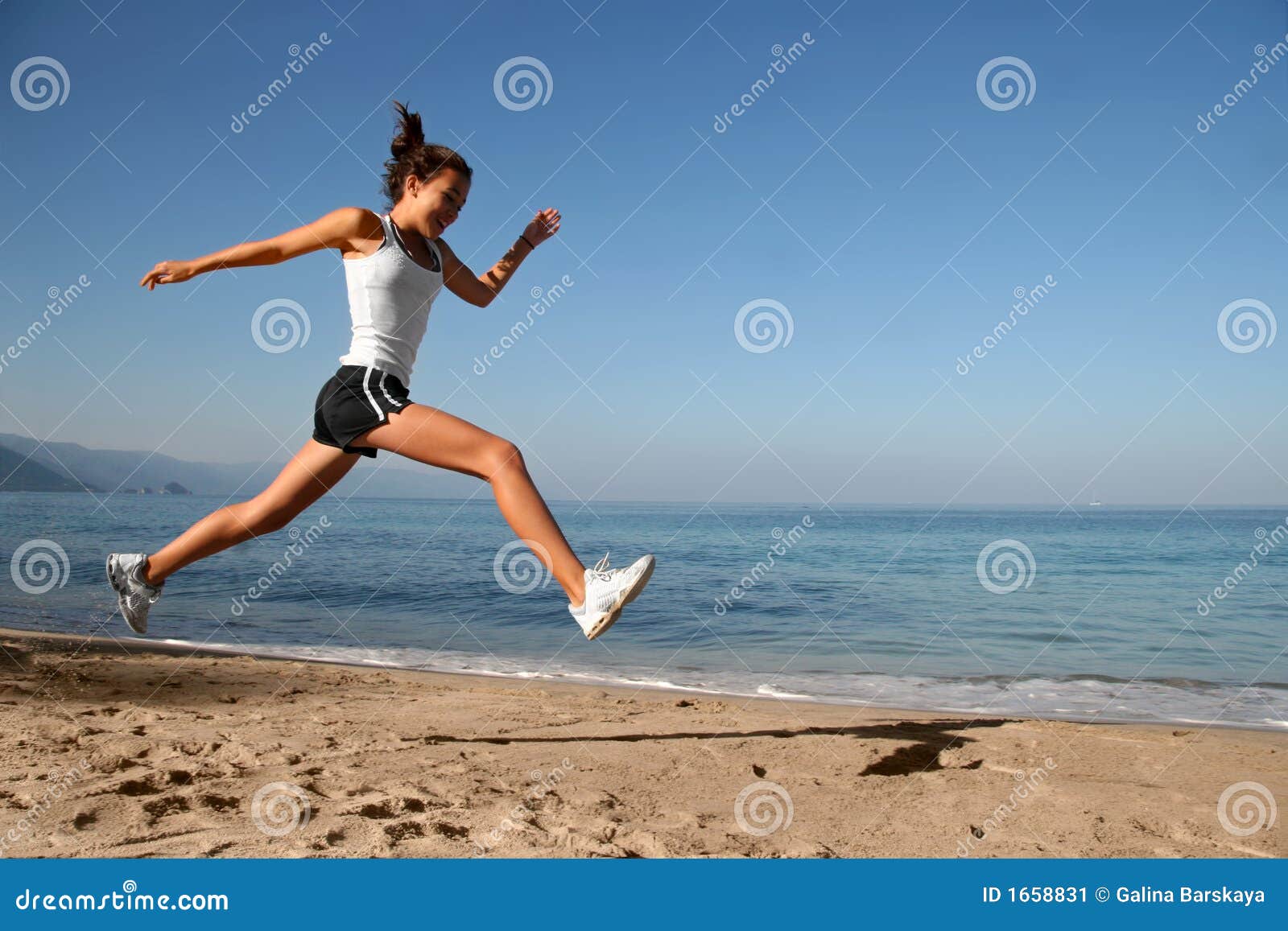 Jumping on the beach stock image. Image of ocean, athletic - 1658831