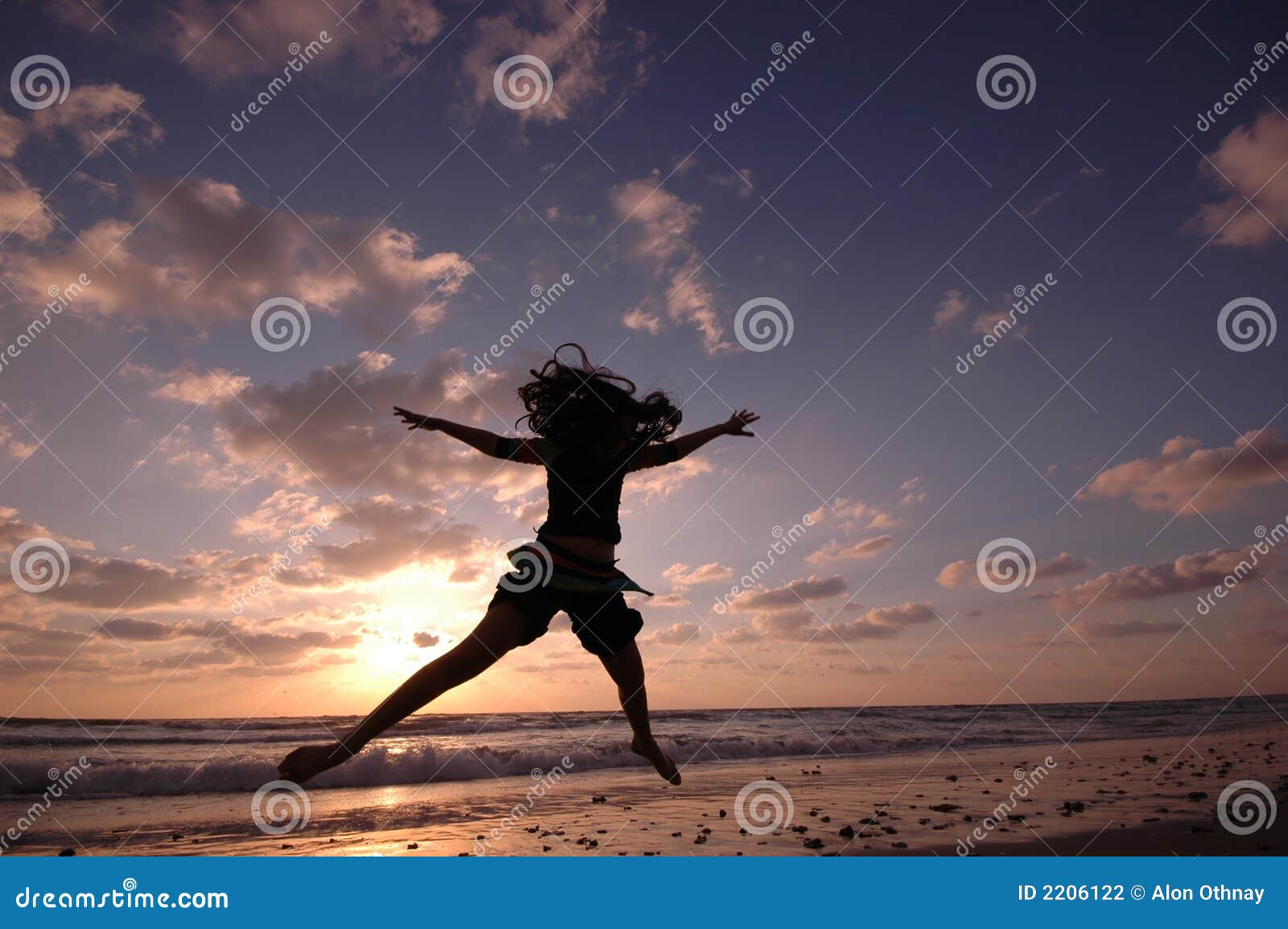 Jumping on the beach stock photo. Image of hand, sunset - 2206122