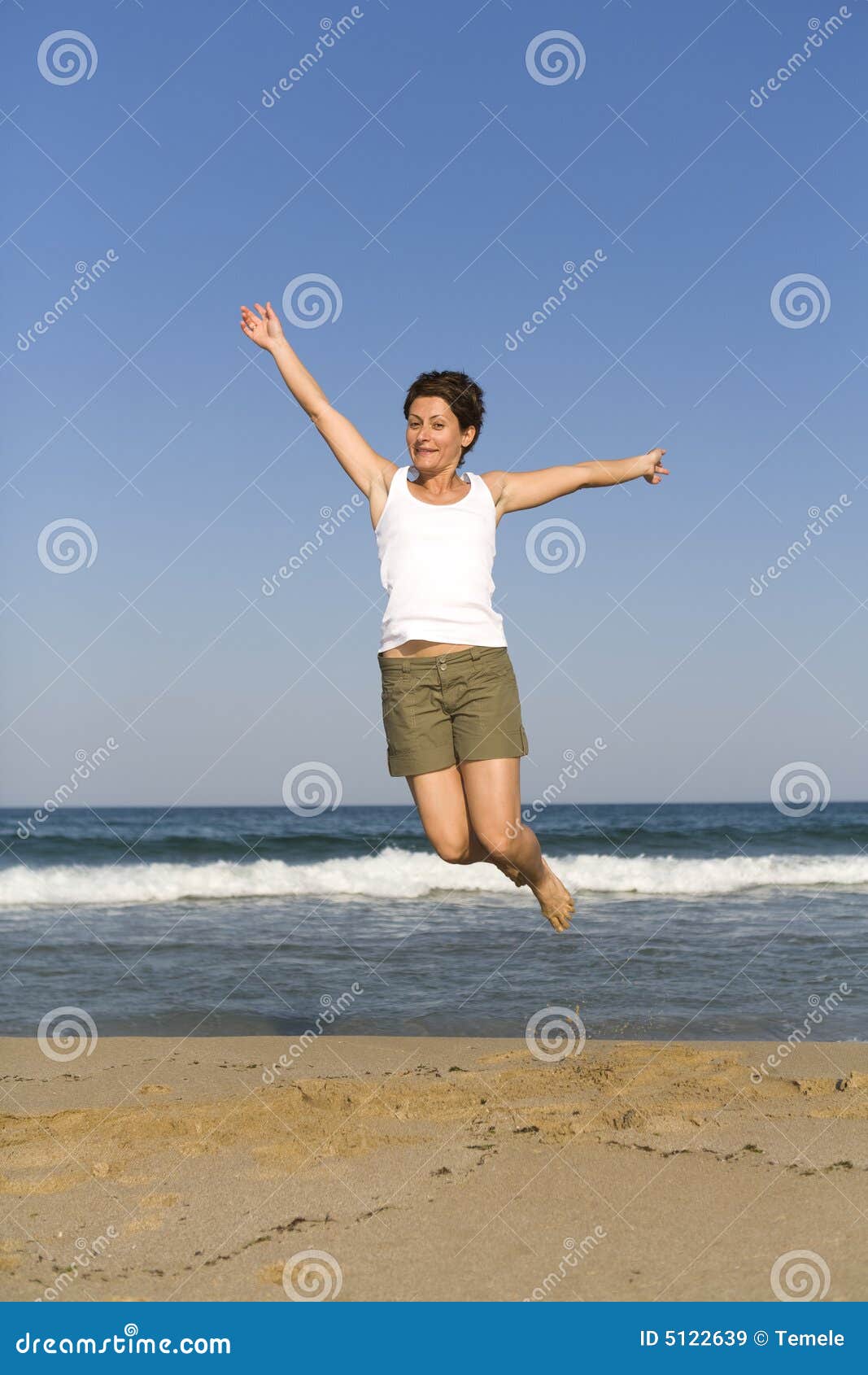 Jumping on the beach stock image. Image of smile, ocean - 5122639