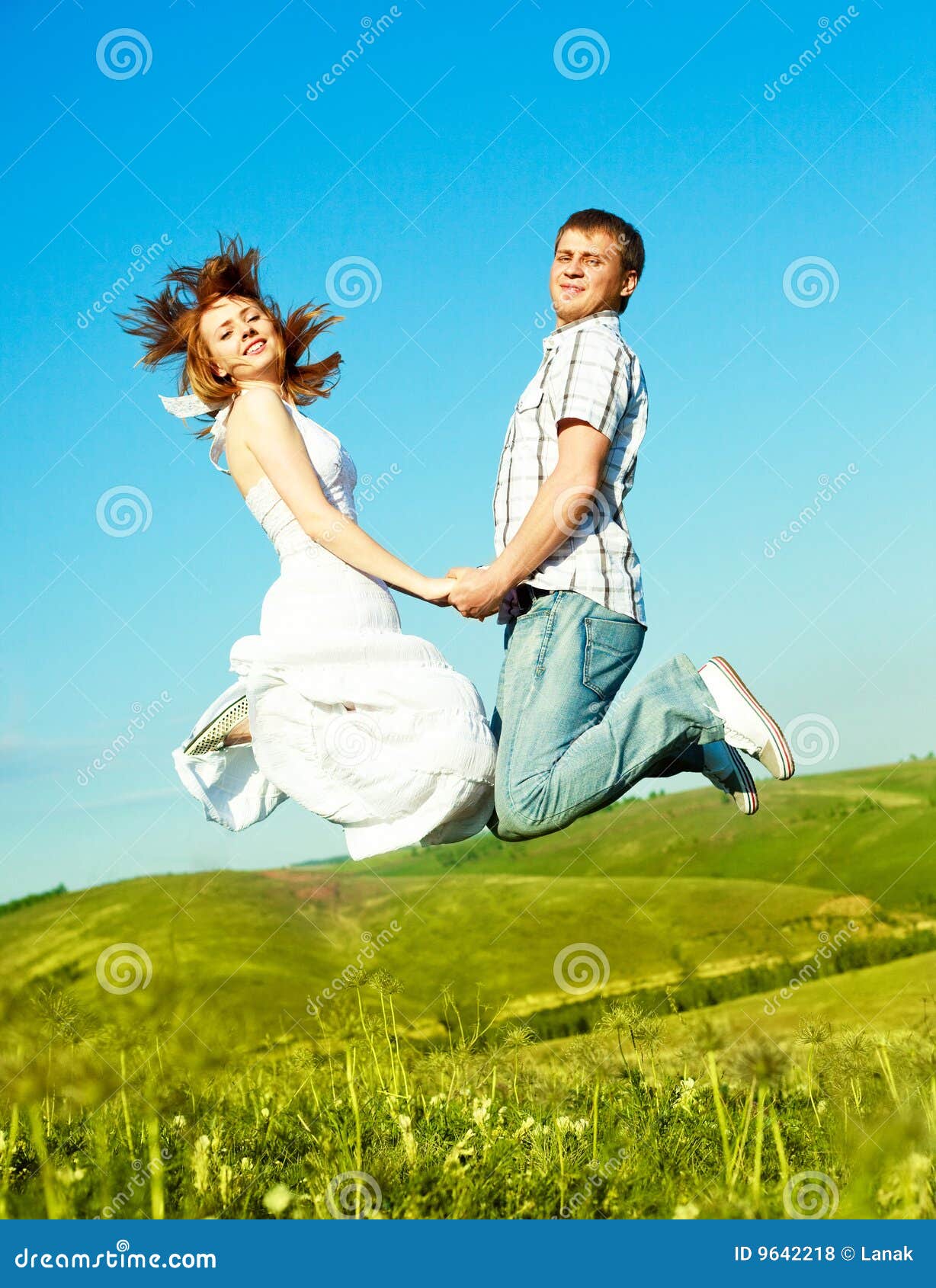 Jumping couple stock photo. Image of field, grass, embrace - 9642218