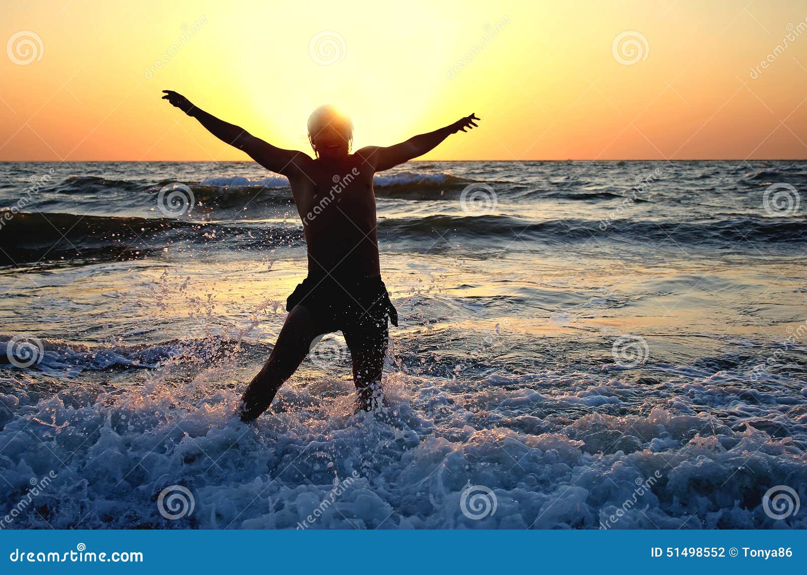 Jumping for Joy in the Sunset on the Ocean Stock Photo - Image of ...