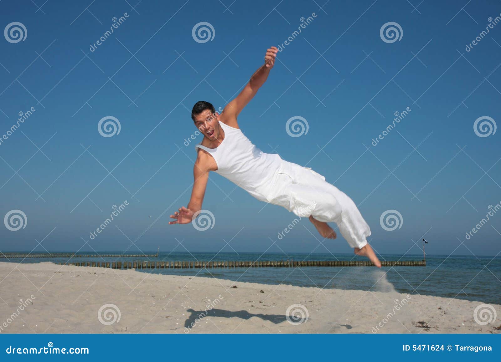Jumping Man Flying High on the Beach Stock Photo - Image of hair, male ...