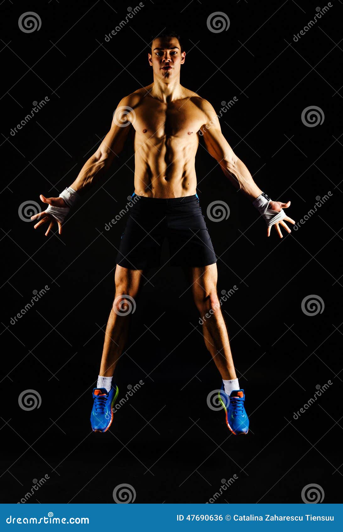 Jumping muscular man stock photo. Image of arms, model - 47690636