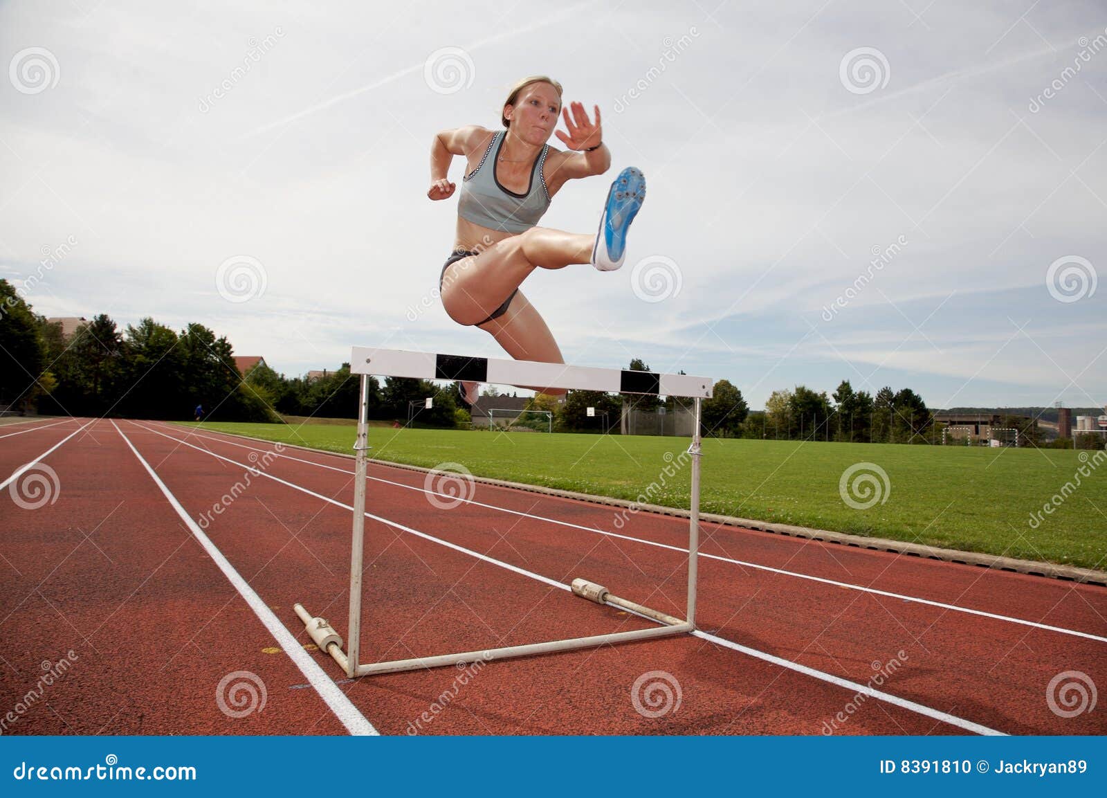 Jumping over a hurdle stock photo. Image of competetion - 8391810