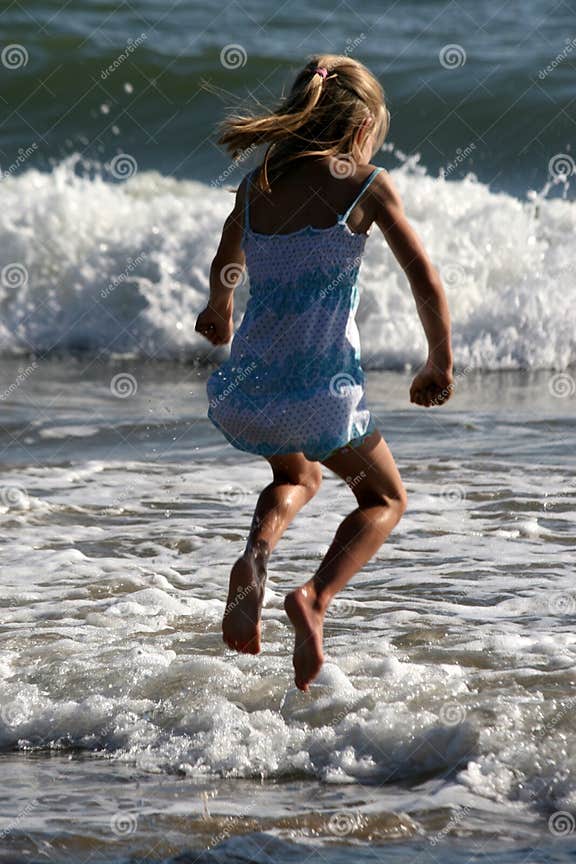 Jumping over the waves stock photo. Image of vacation - 10925736