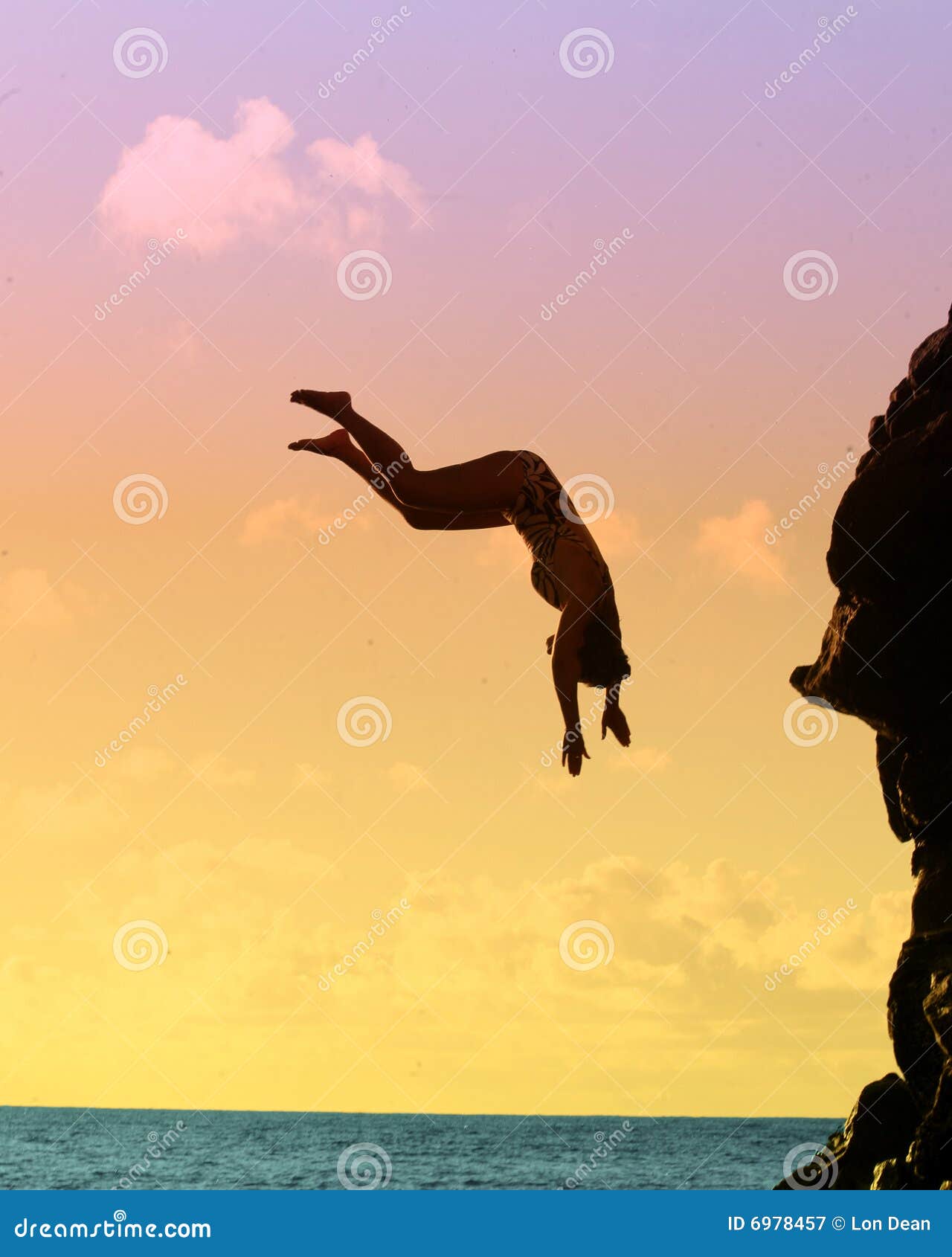 Jumping of rock into water stock image. Image of yellow - 6978457