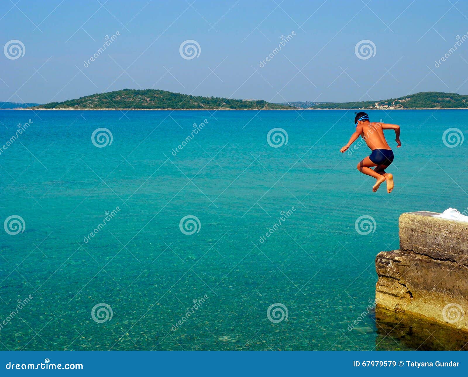 Jumping into the sea. stock image. Image of rocky, active - 67979579