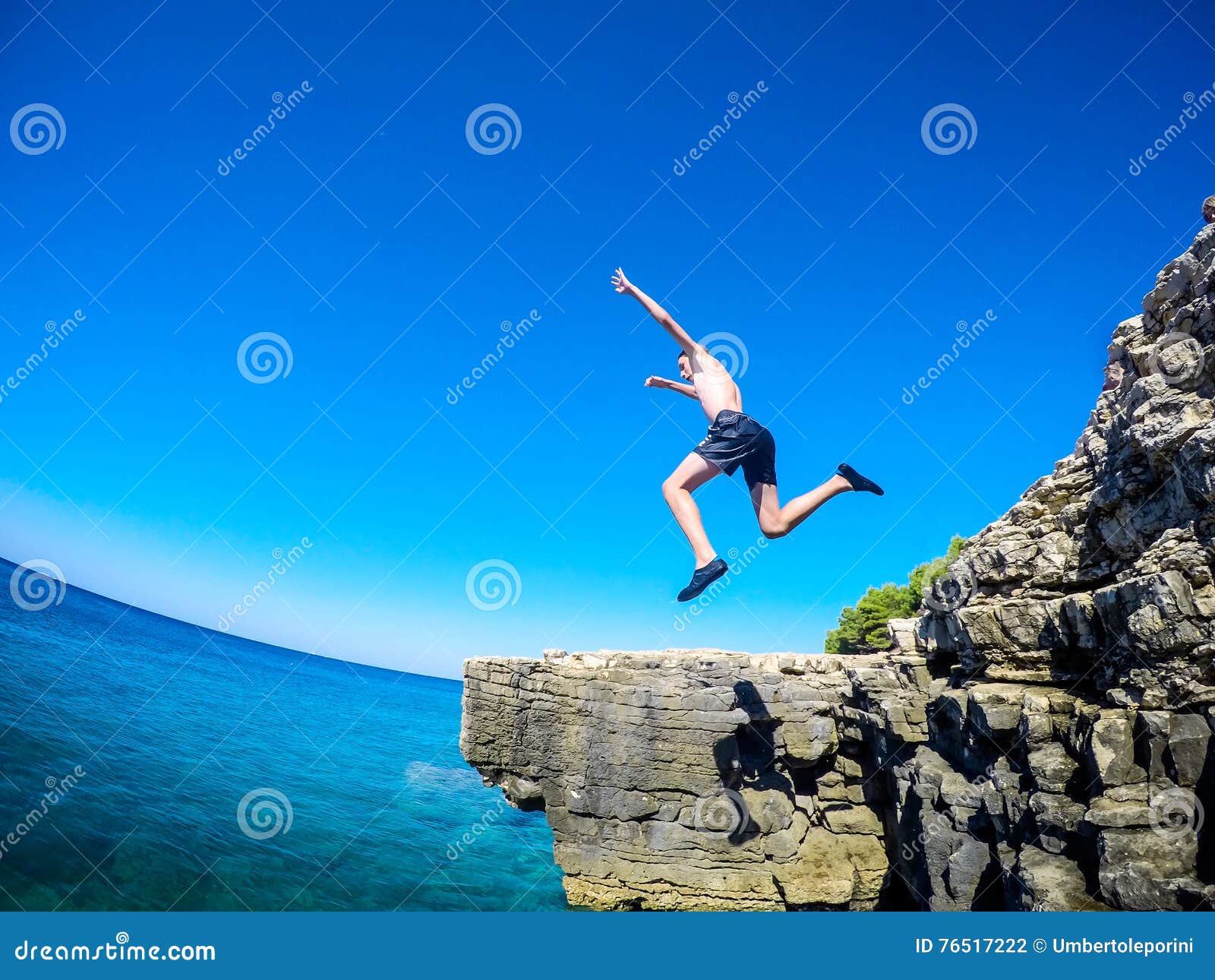 Jumping in to the sea stock photo. Image of holidays - 76517222