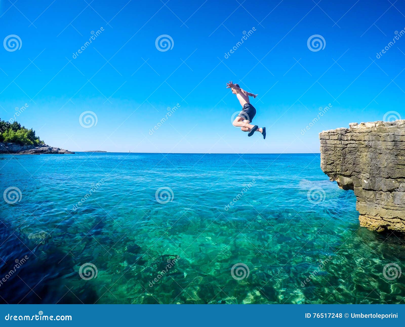 Jumping in to the sea stock photo. Image of holidays - 76517248