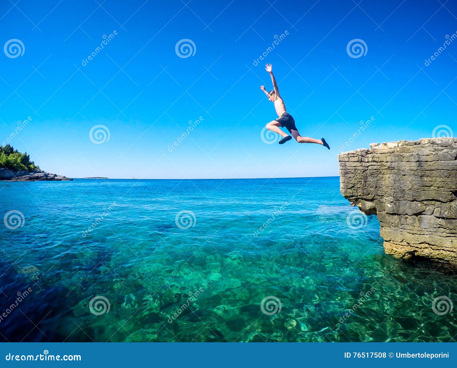 Jumping in to the sea stock photo. Image of child, plunge - 76517508